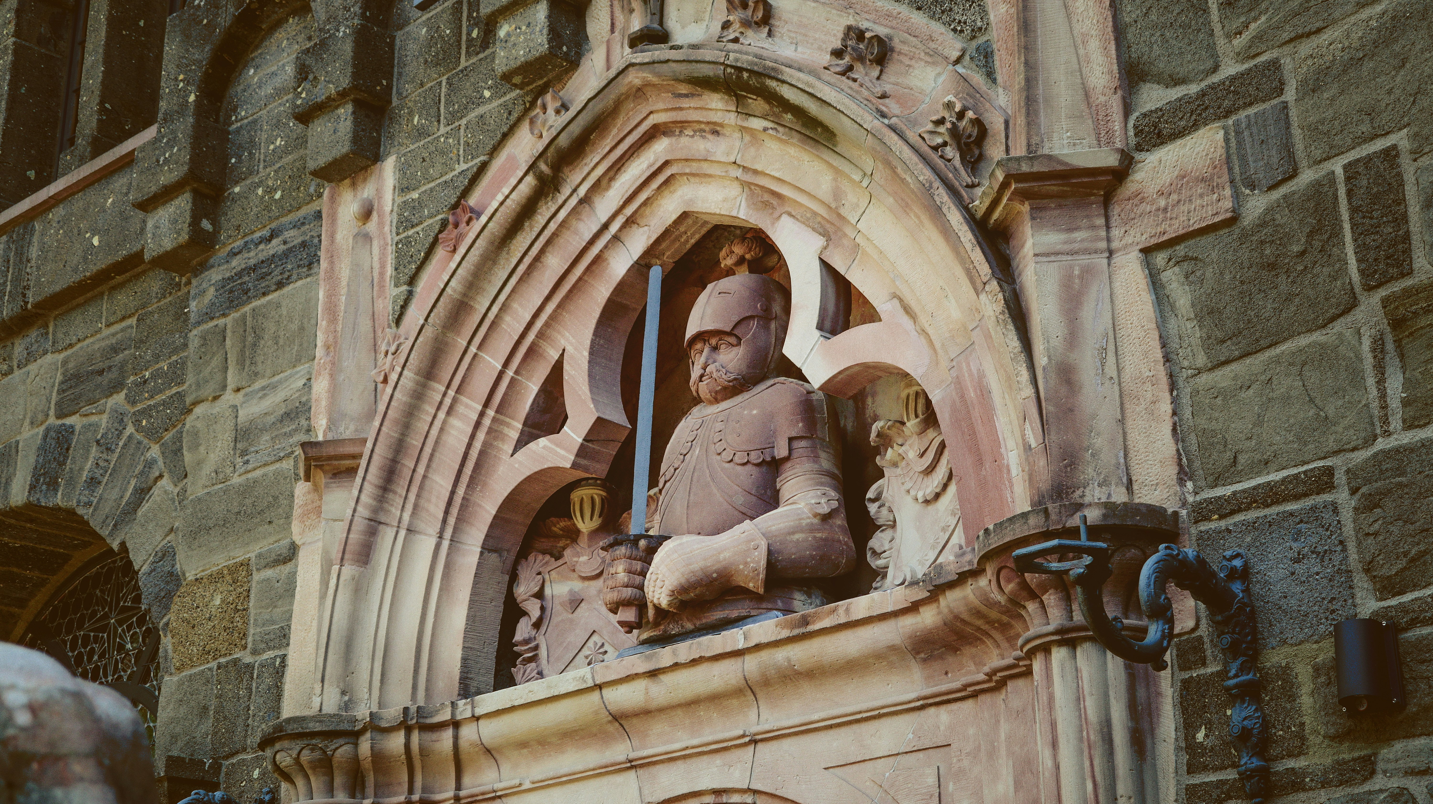A statue of a man sitting in a window photo – Free Kassel Image on Unsplash
