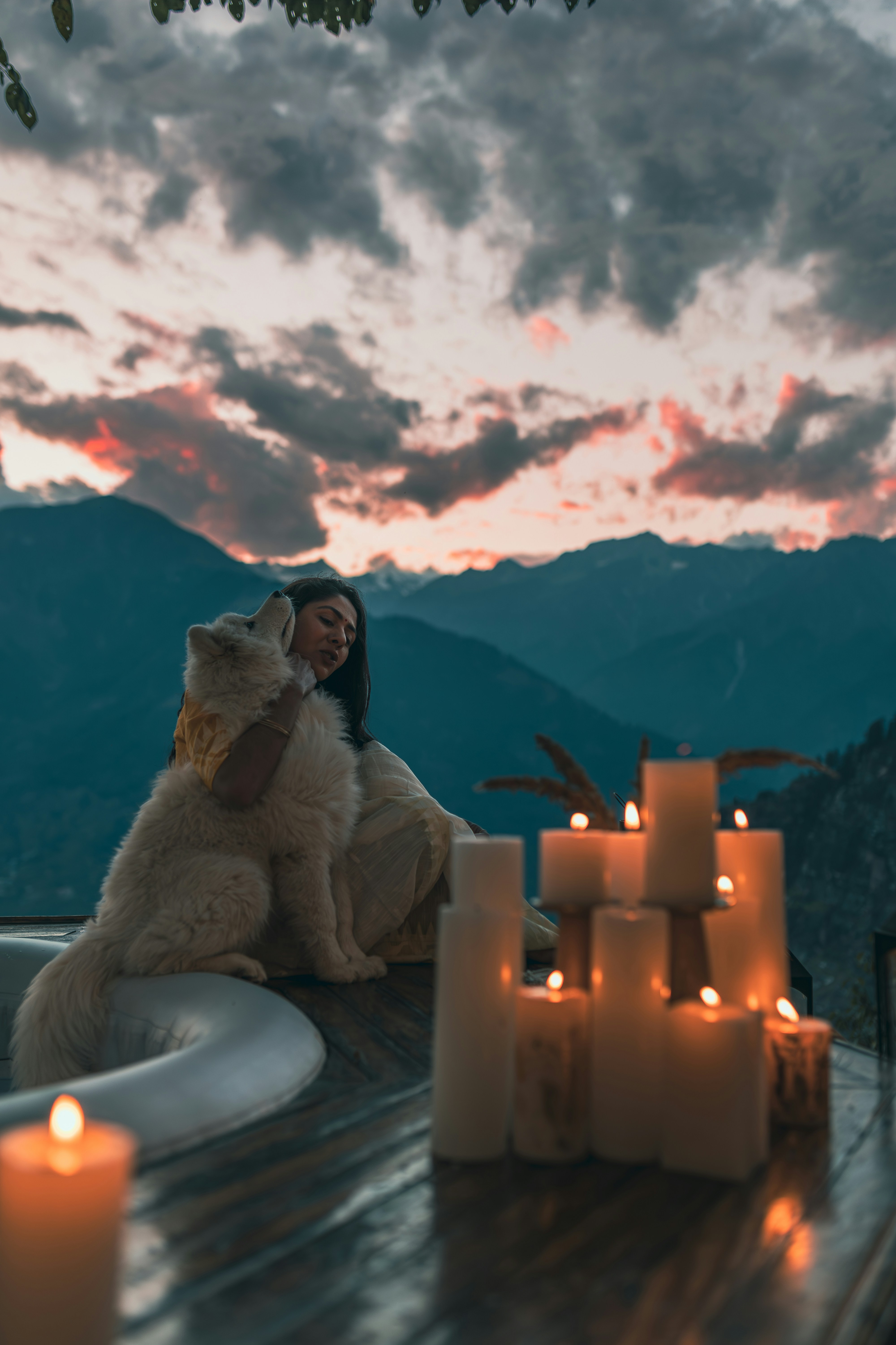 Moonlit Terrace: A Woman and Dog by Candlelit Steps with Mountain Silhouette