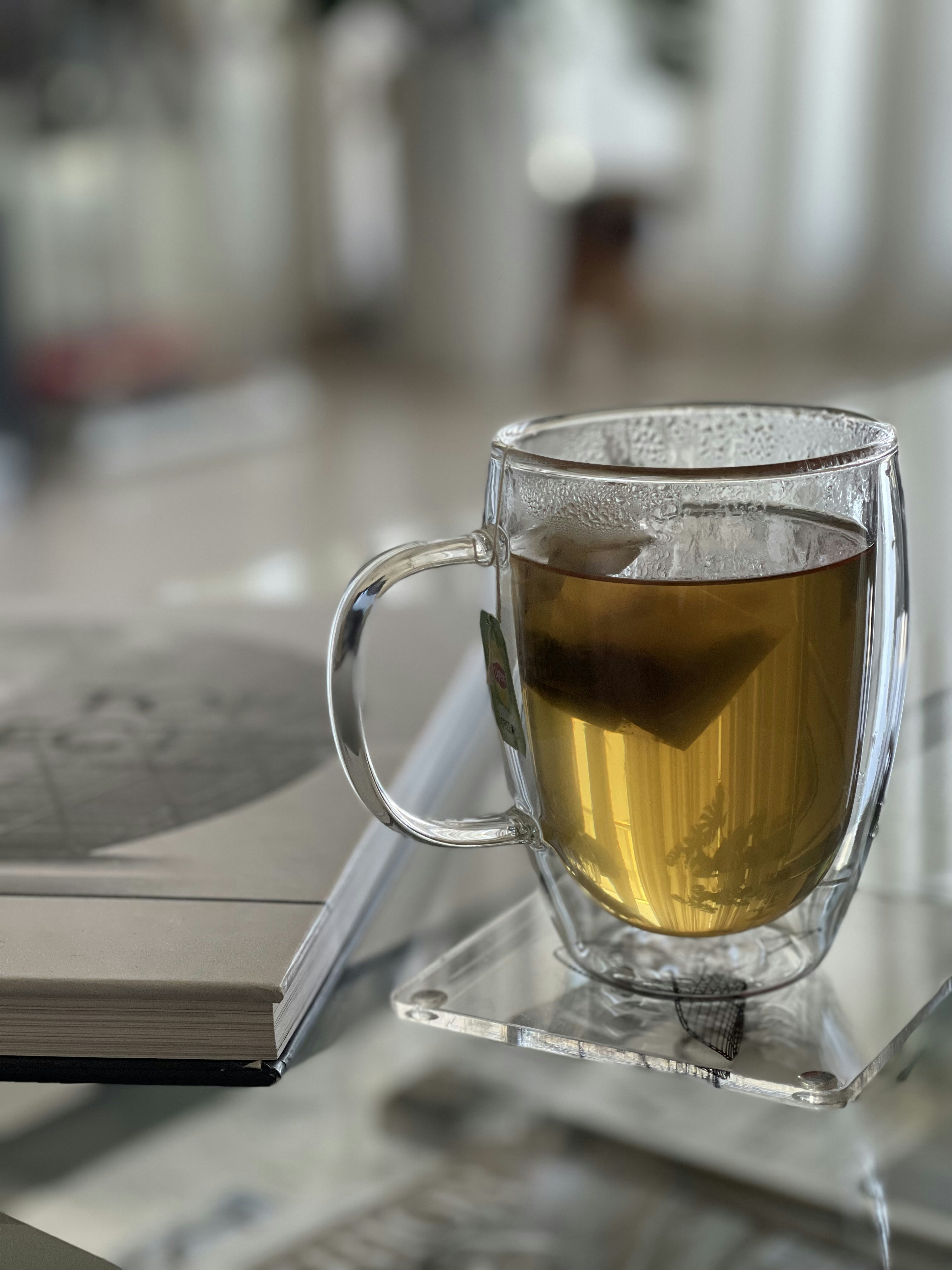A cup of tea sitting on top of a glass table photo – Free Tea Image on ...