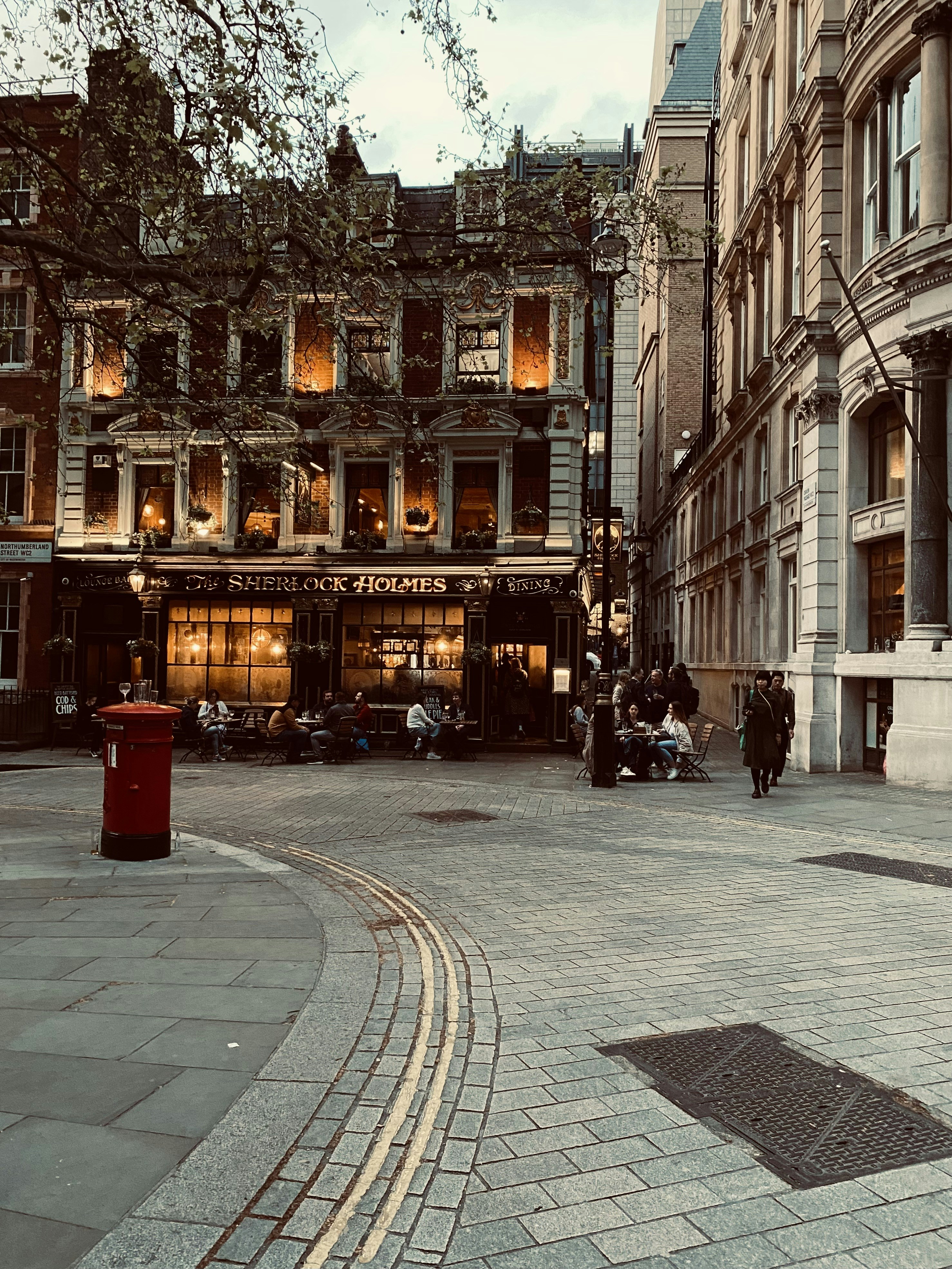 Lamplight on Sherlock Lane: Cozy Evening by the Pub Facade