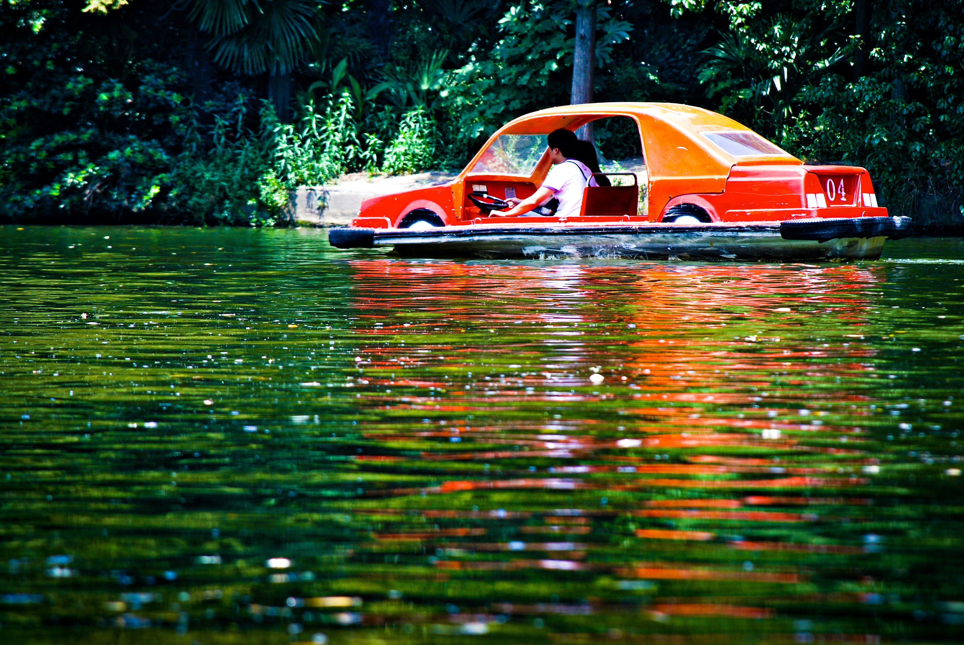Sunlit Orange Cab Afloat: A Surreal Lake Taxi