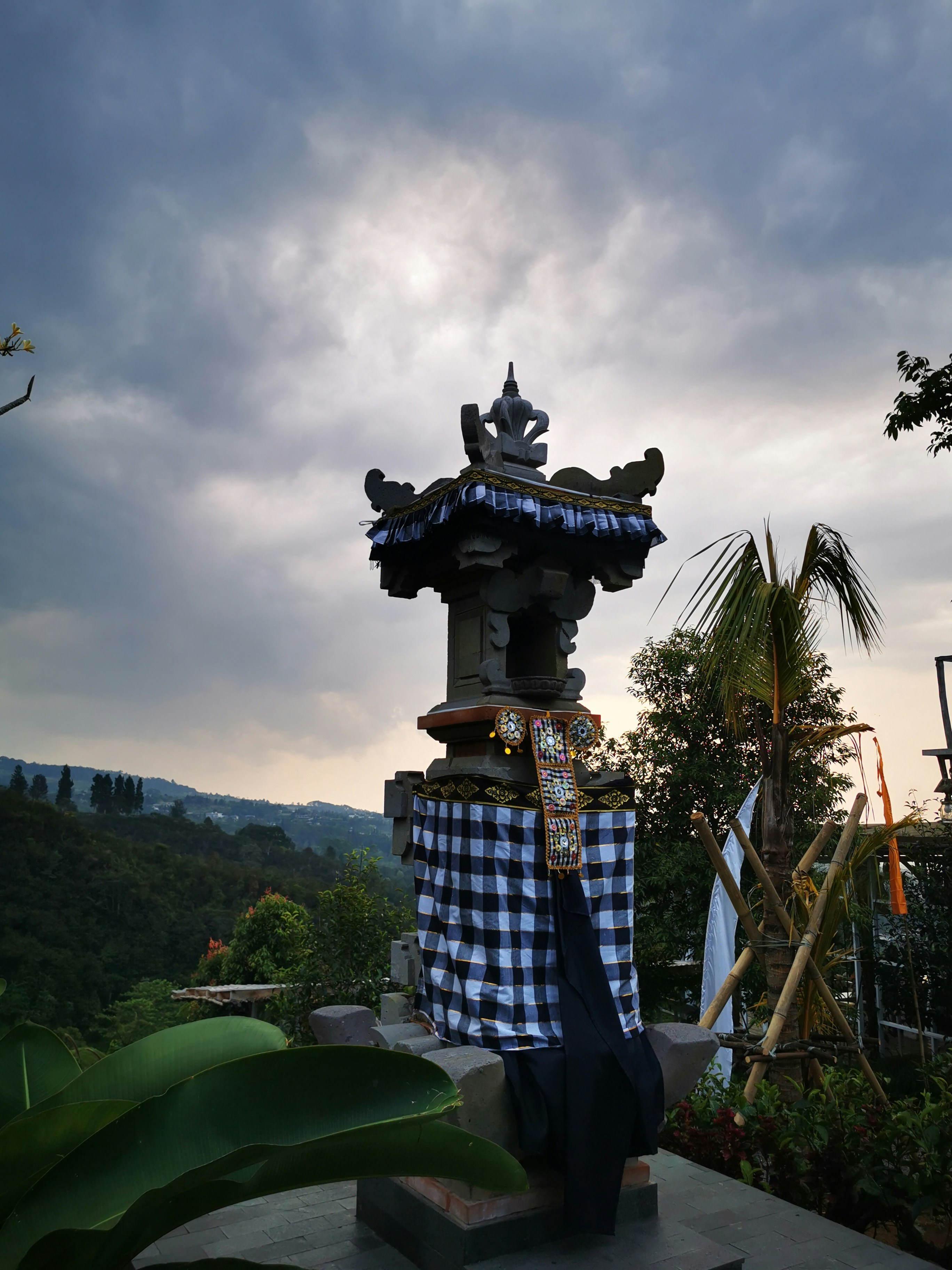 Draped Shrine Sentinel Against a Cloudy Hillscape