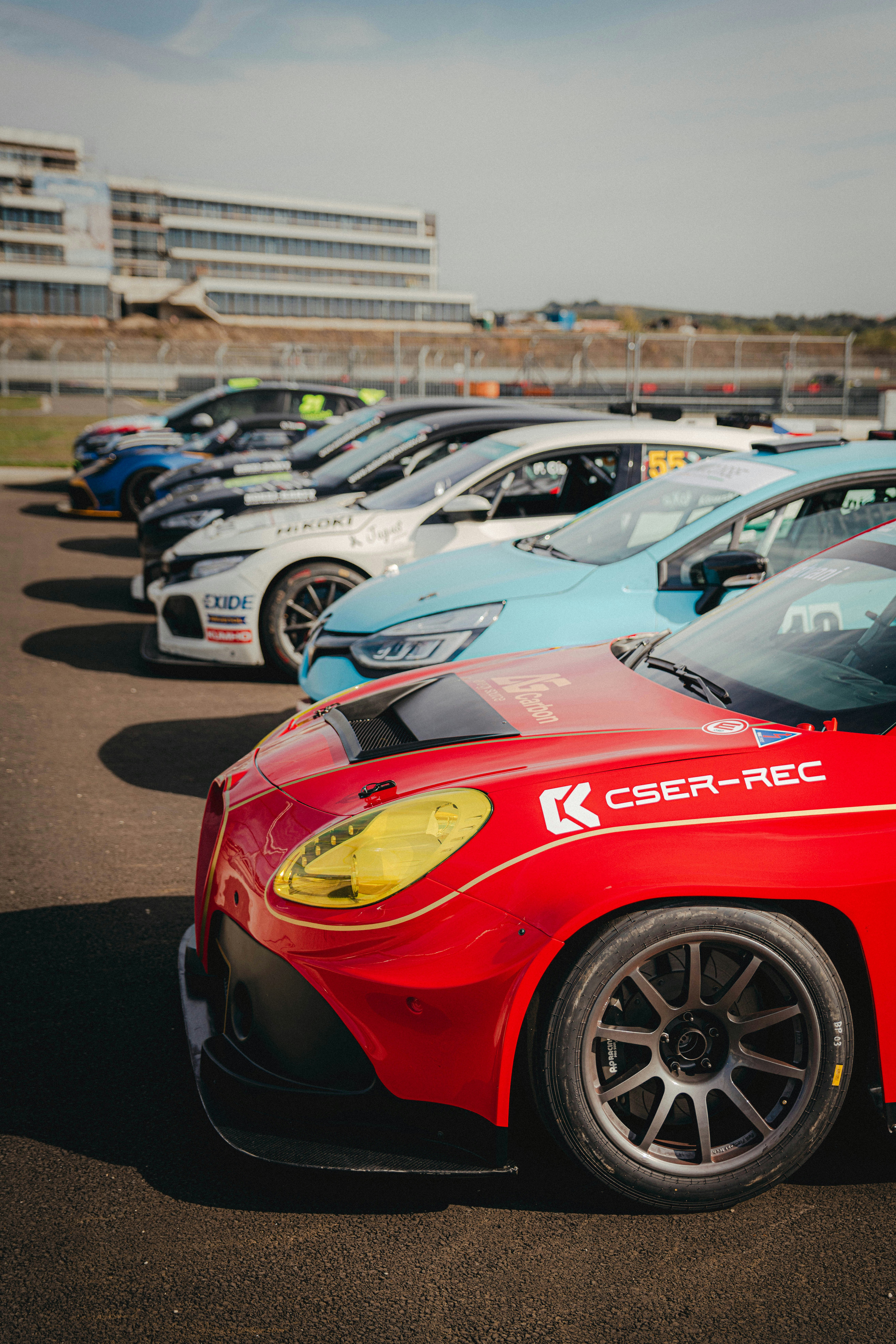 Front-Row Fire: A crimson racer leads a line of speed machines