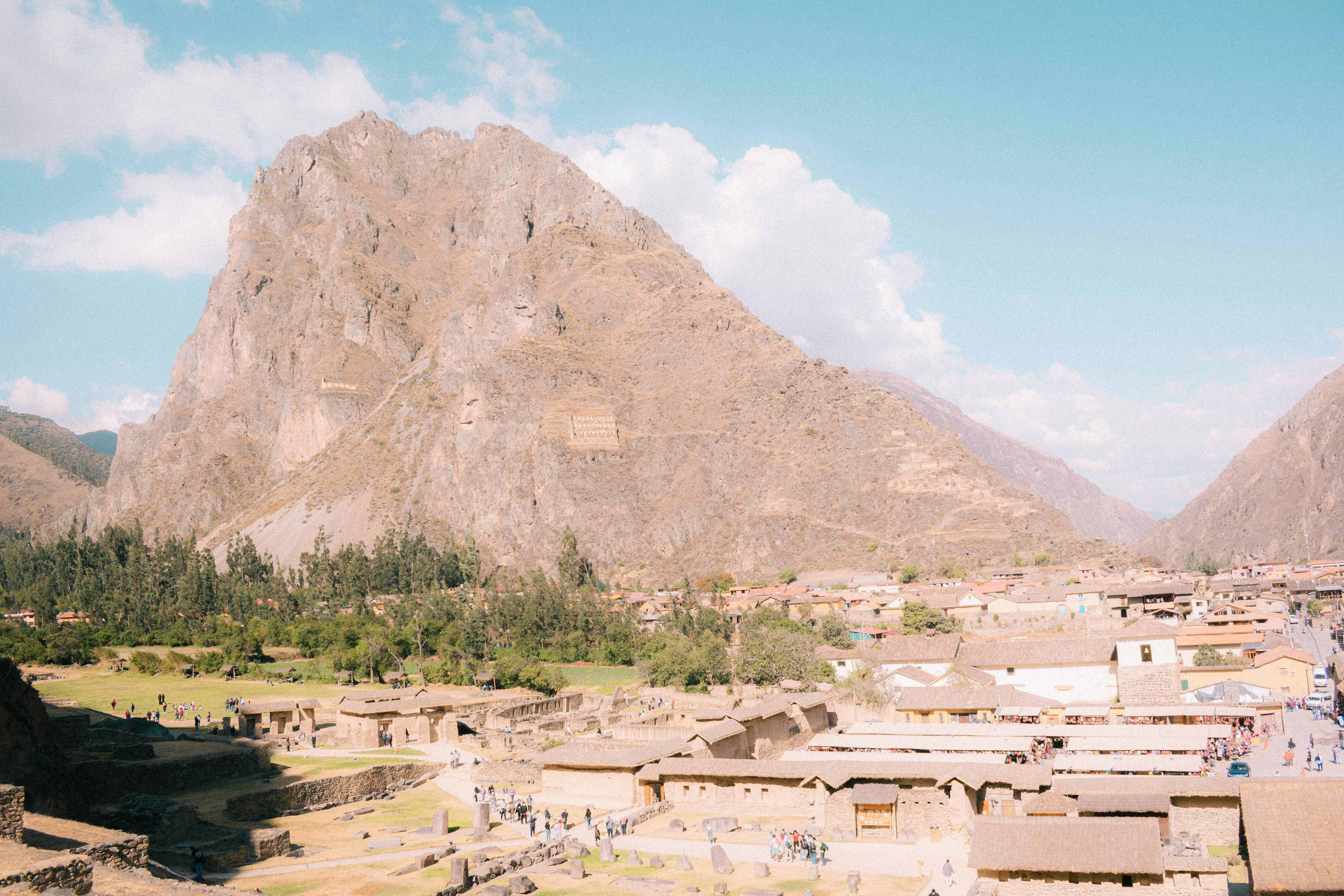 a group of people standing in front of a mountain