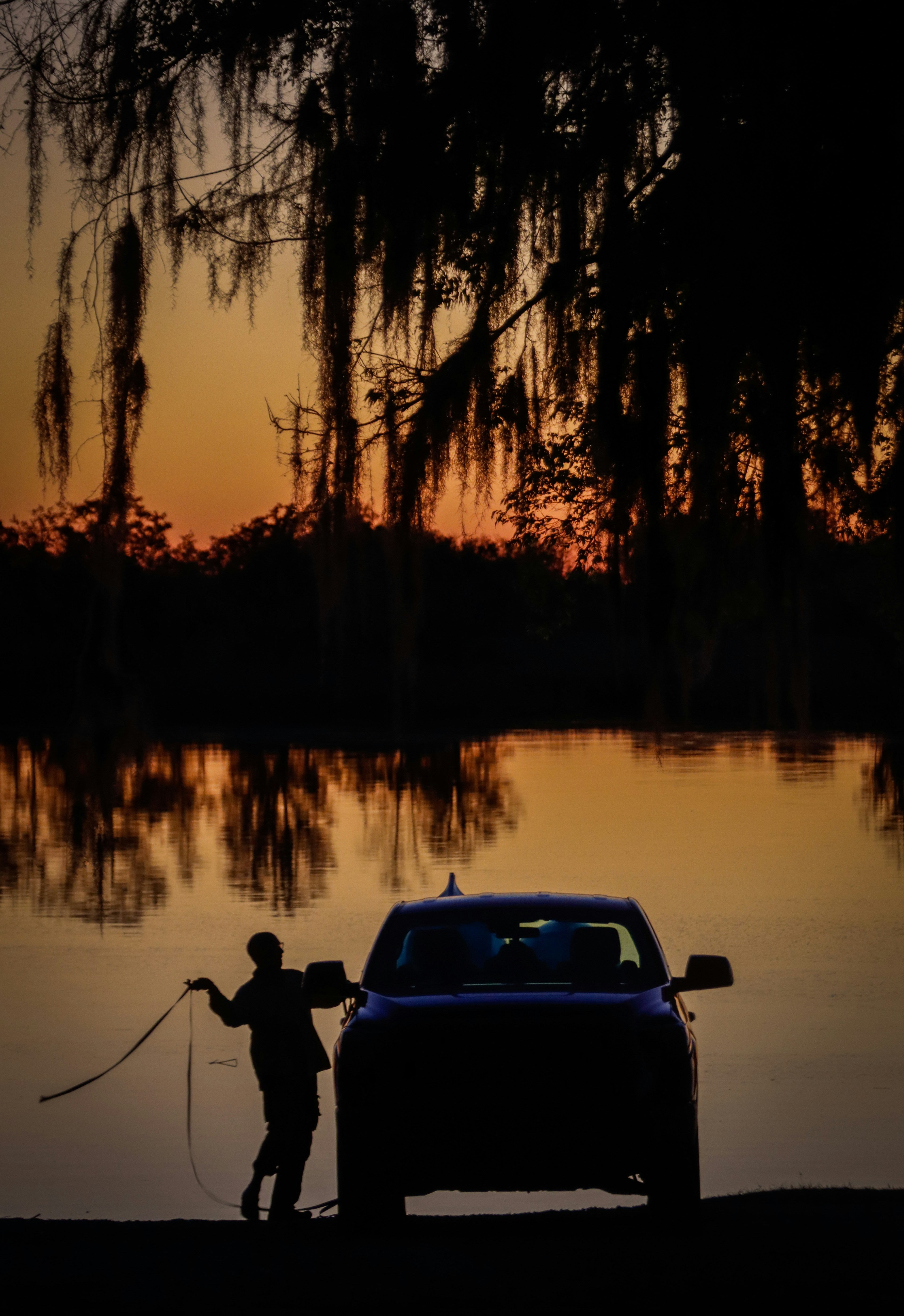 Silhouette at Dusk: A Child and Truck by the Water