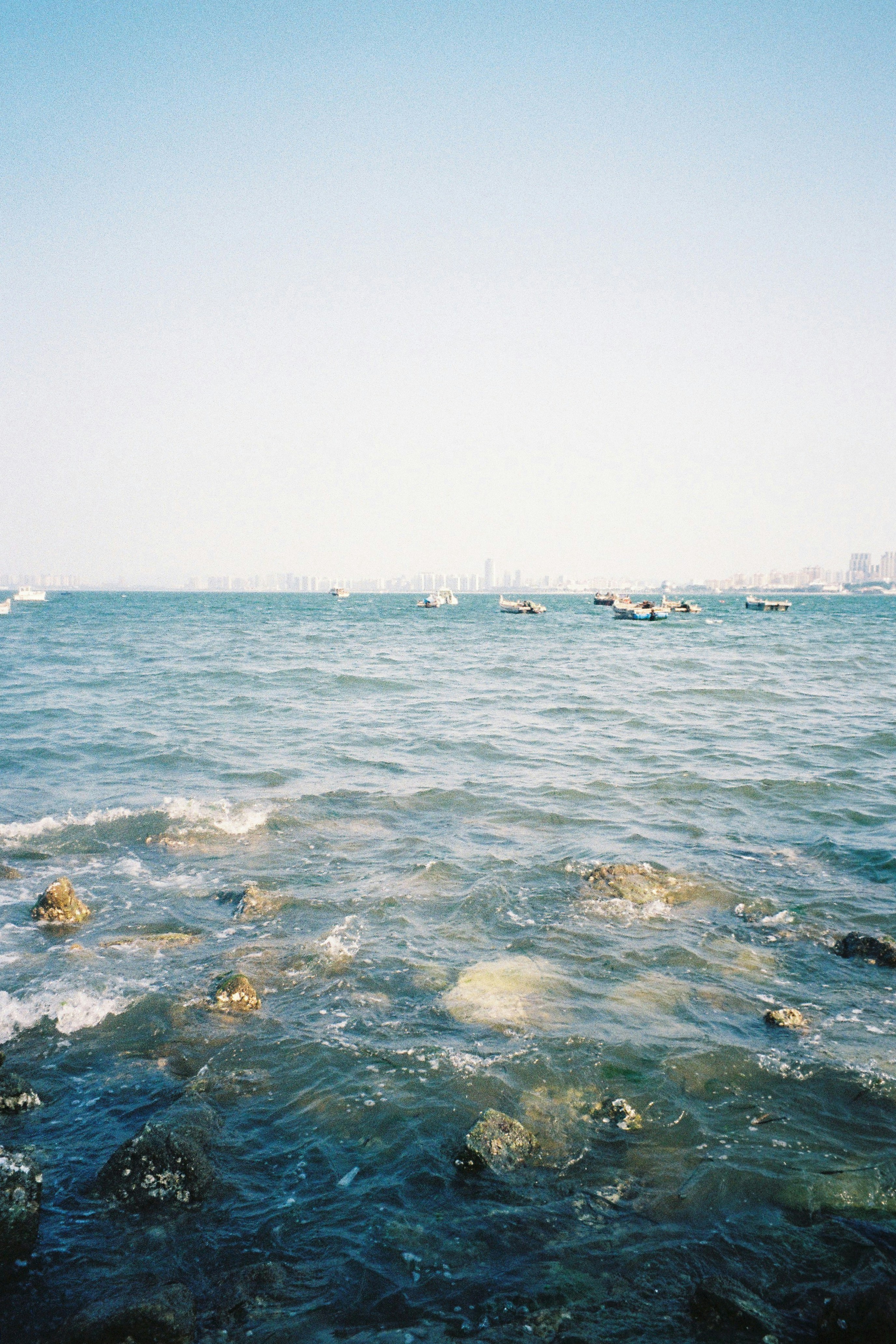 Distant Fleet on a Pale Sea Under a Clear Morning Sky