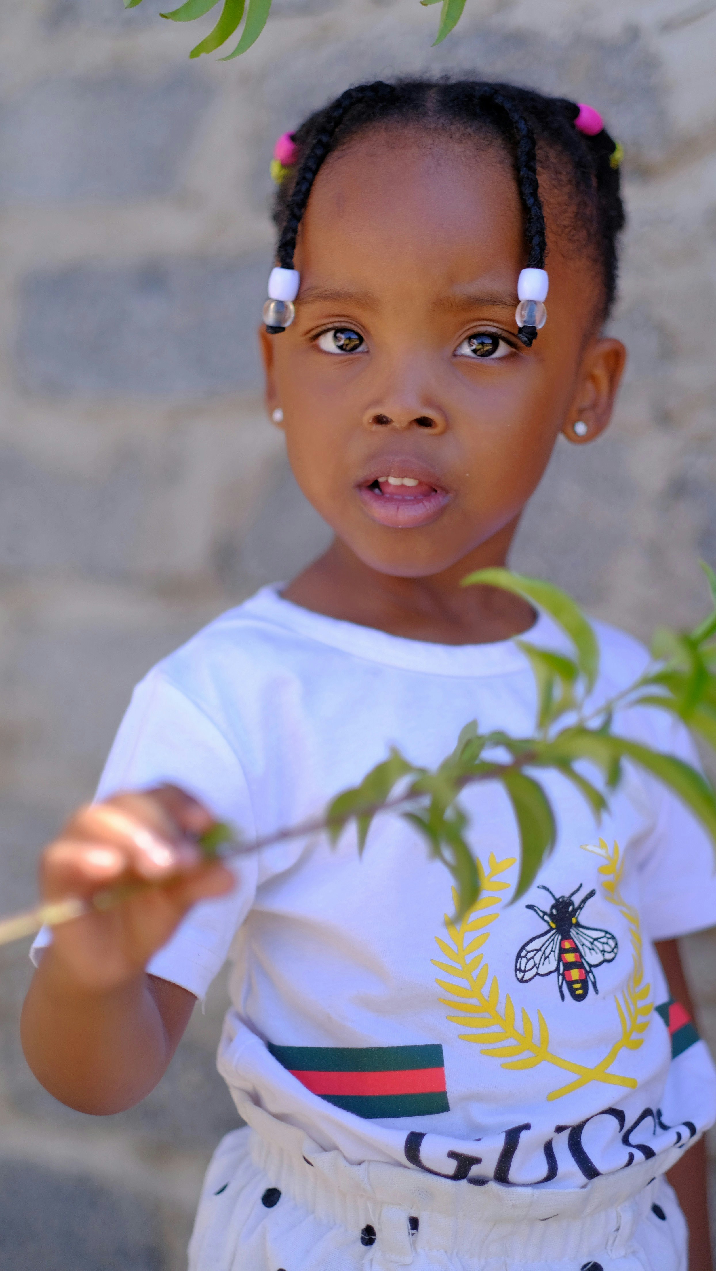 Beaded Gaze: A Quiet Portrait Amid Greenery