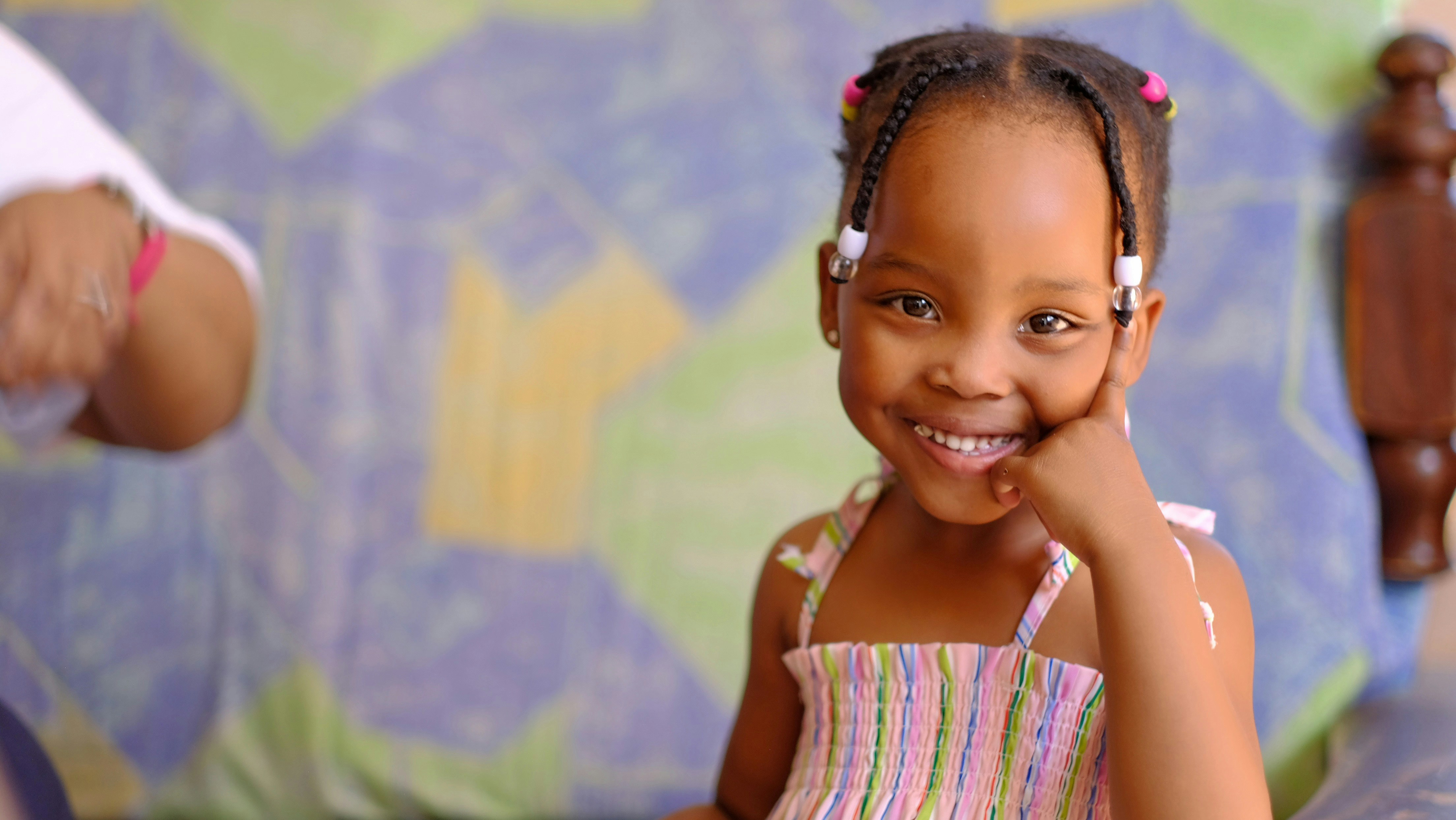 A little girl smiling at the camera with a smile on her face photo ...