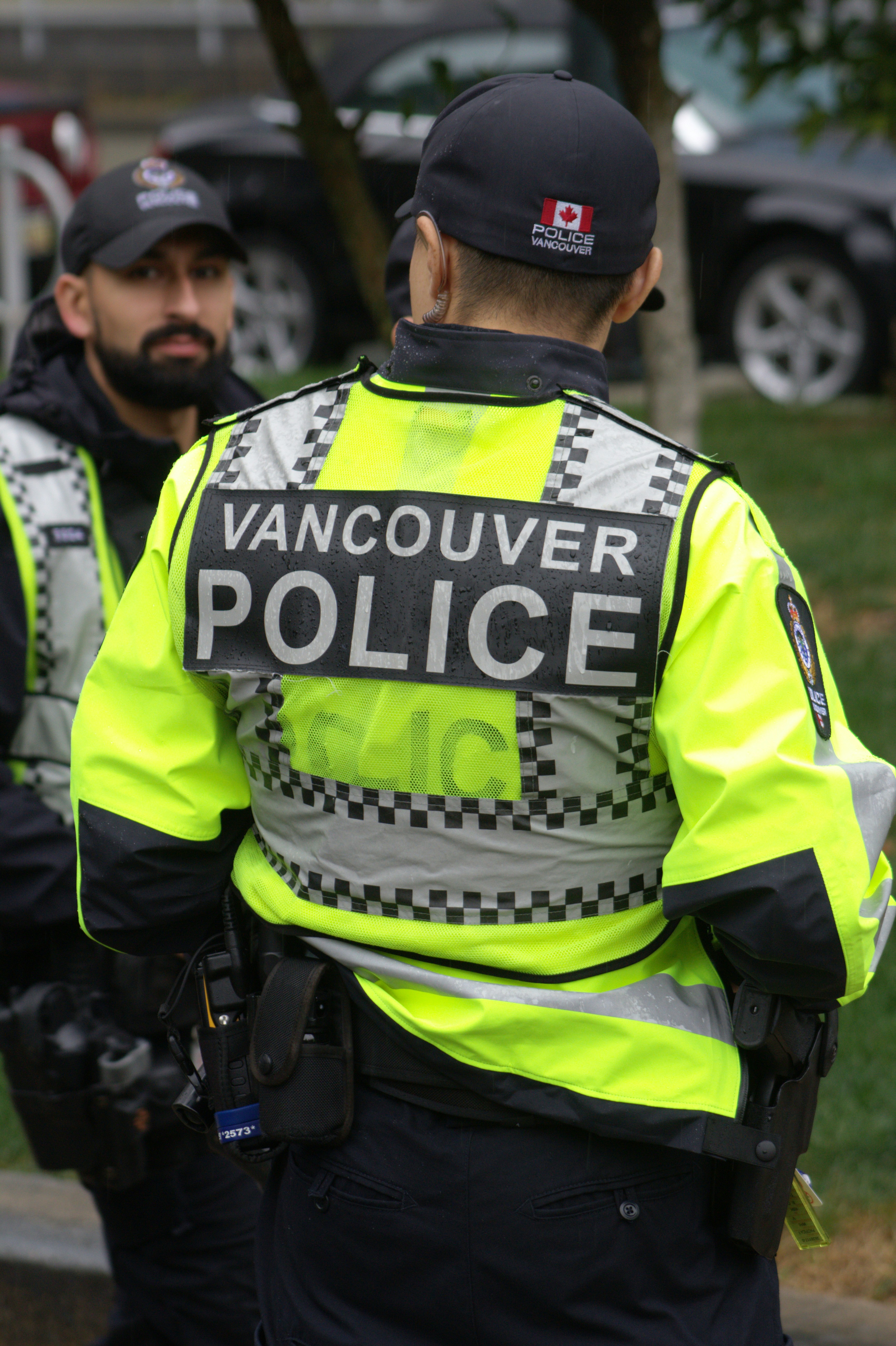 A couple of police officers standing next to each other photo – Free ...