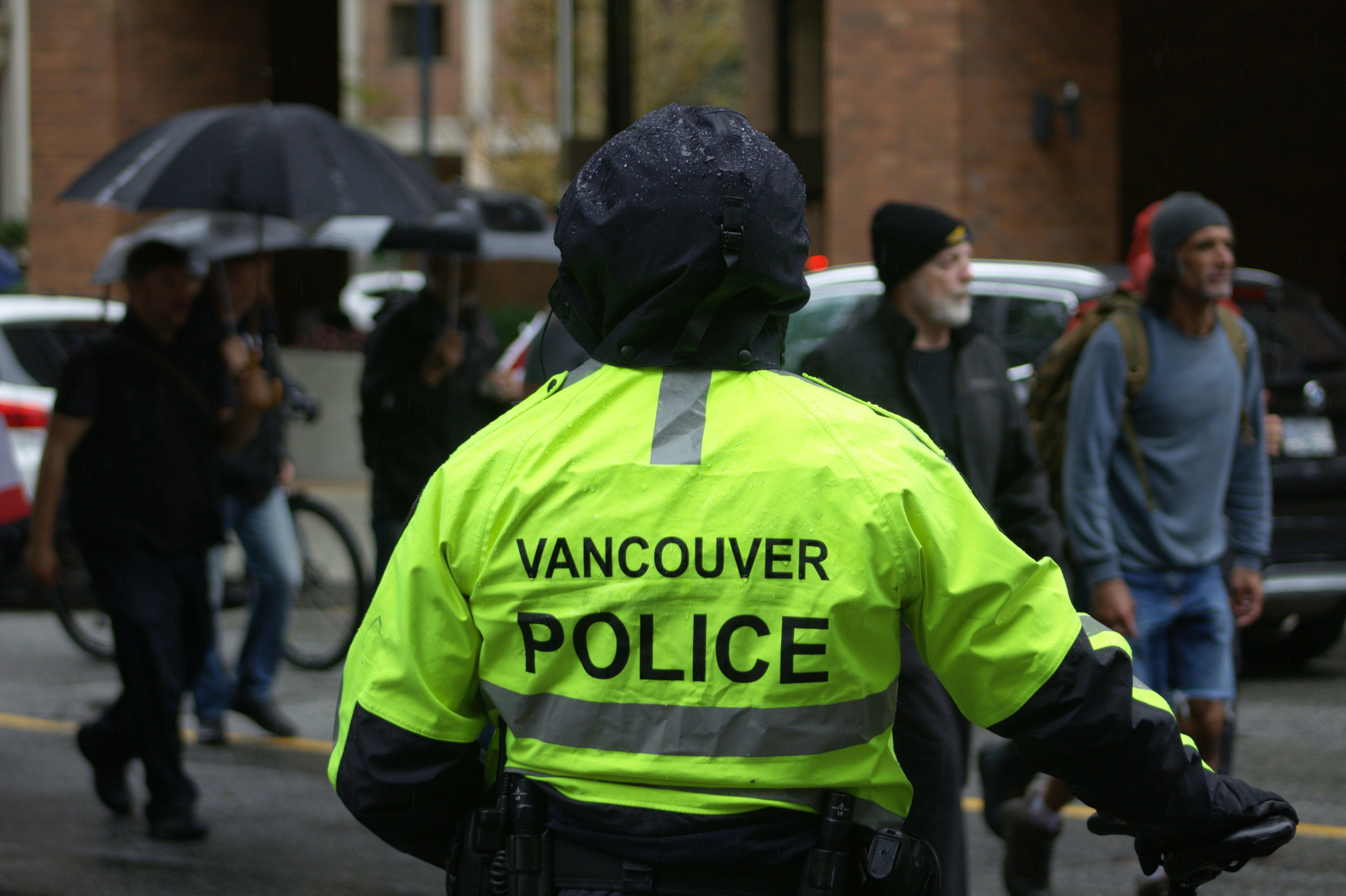A vancouver police officer walking down the street photo – Free Green ...