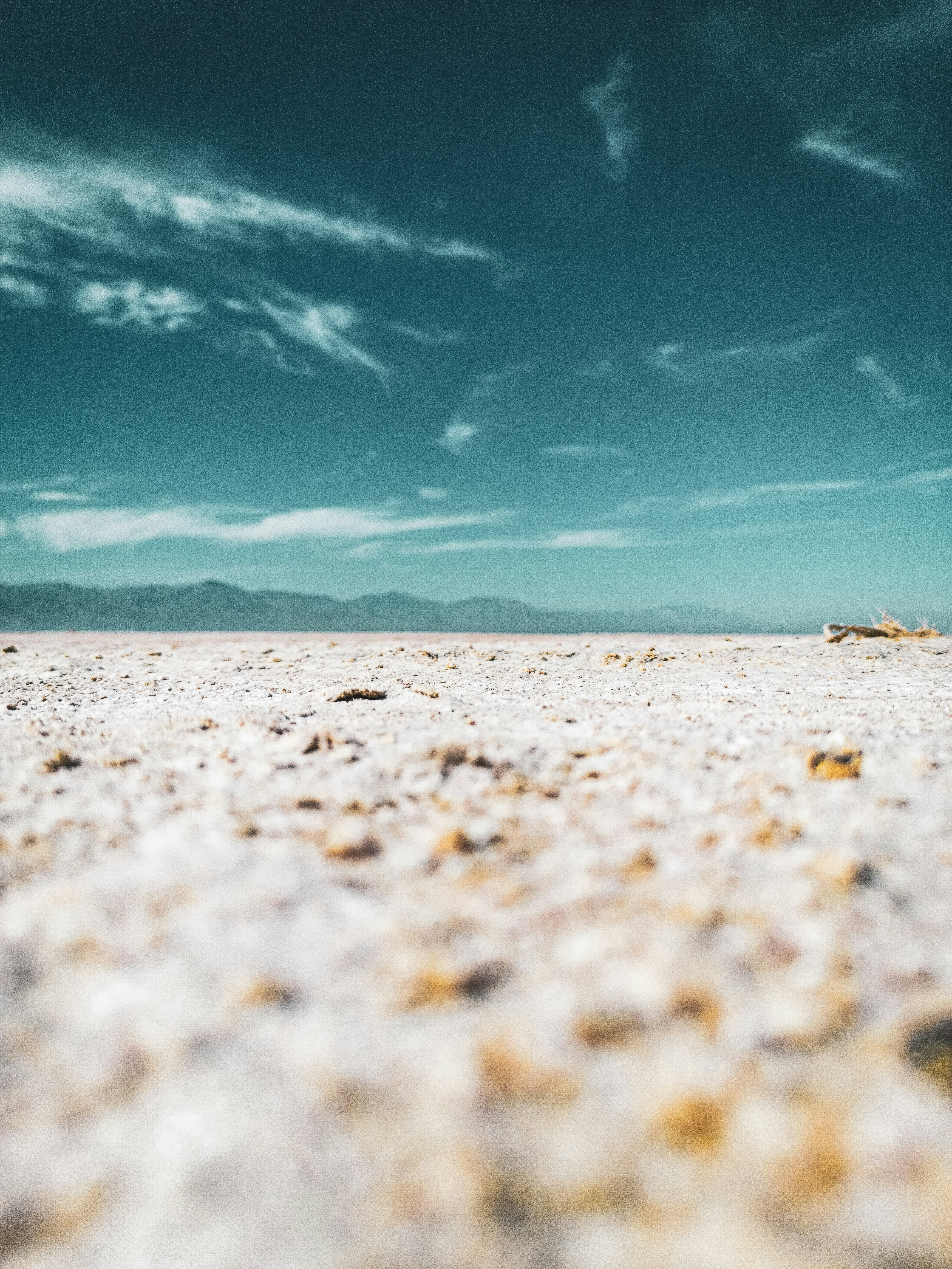 Teal Horizon: Salt-Plain Quiet Beneath a Distant Ridge