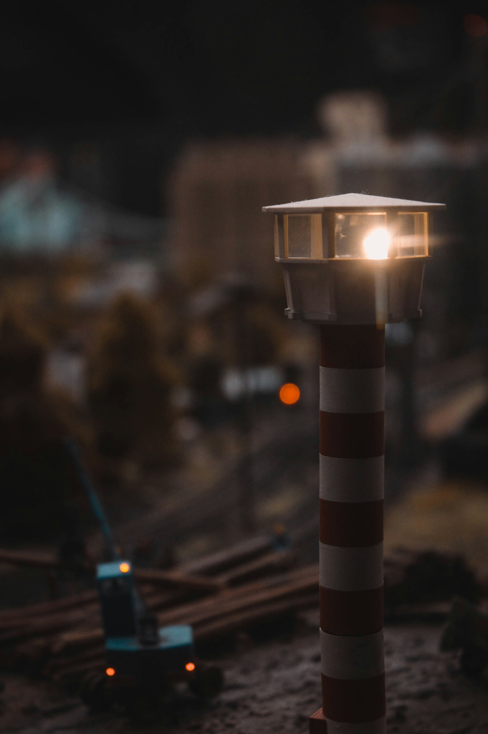 Beacon in the Evening Yard: A Street Lamp with Striped Post