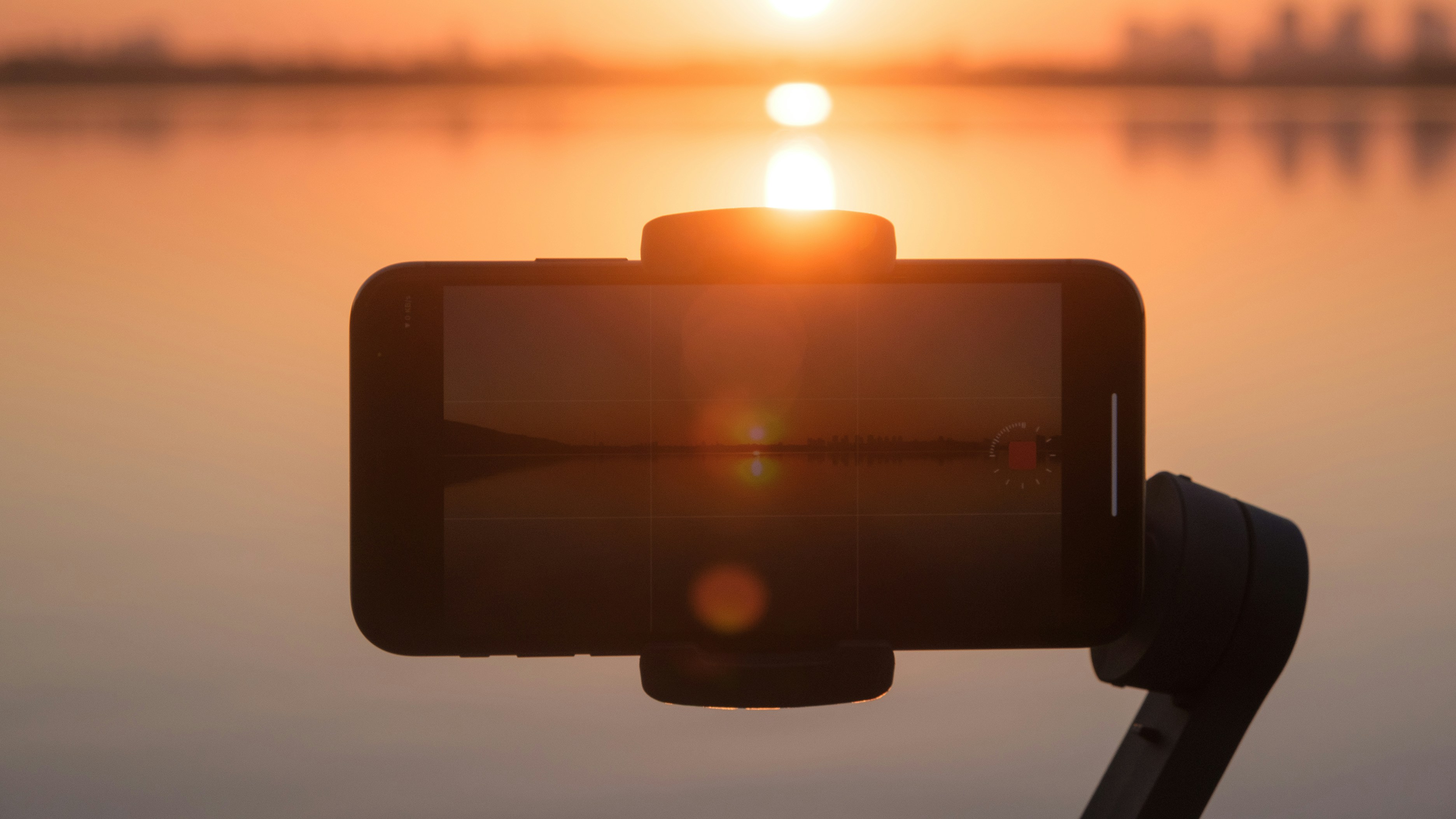 A close up of a camera with a sunset in the background photo – Free ...