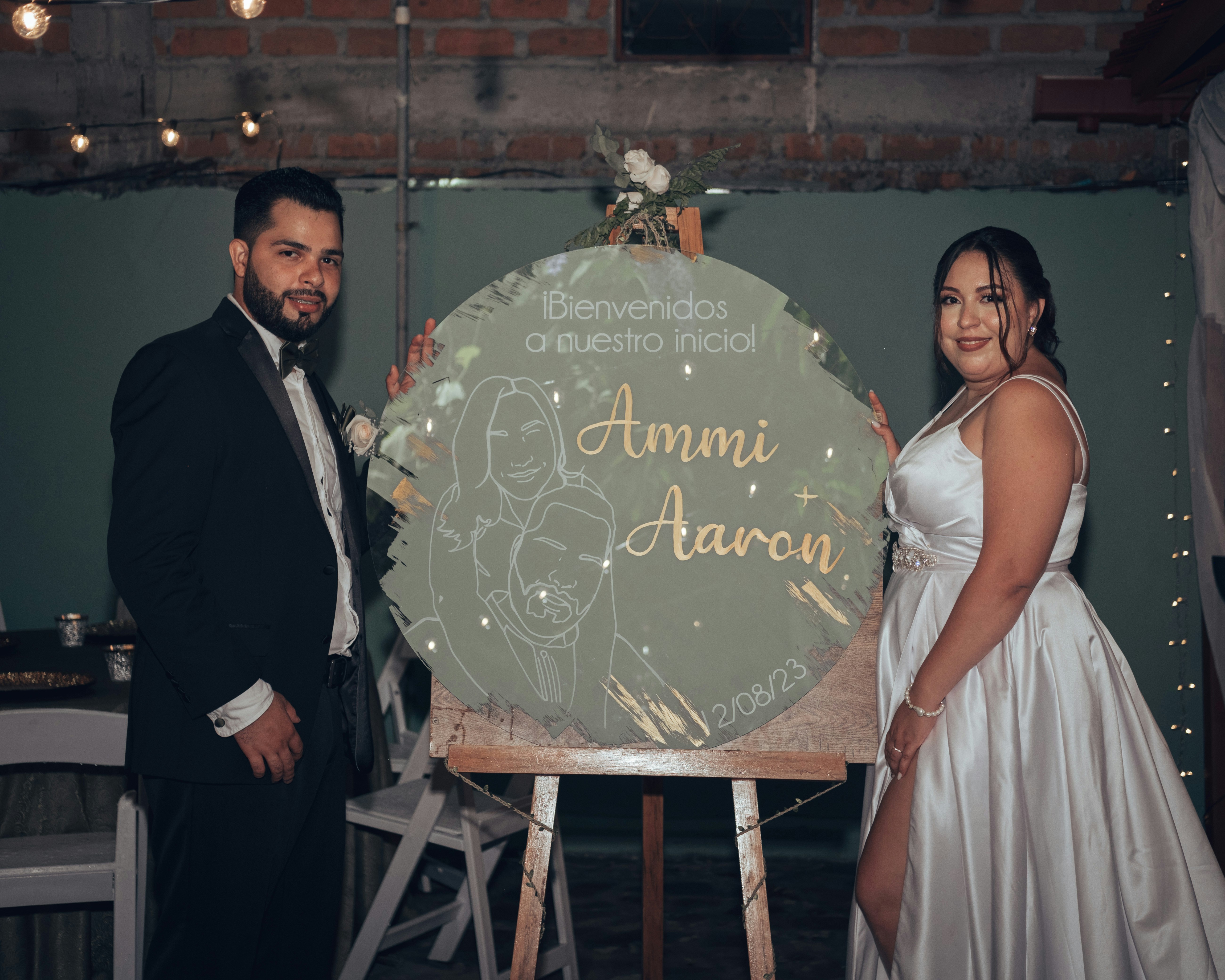 A man and a woman standing next to a sign photo – Free Woman Image on ...