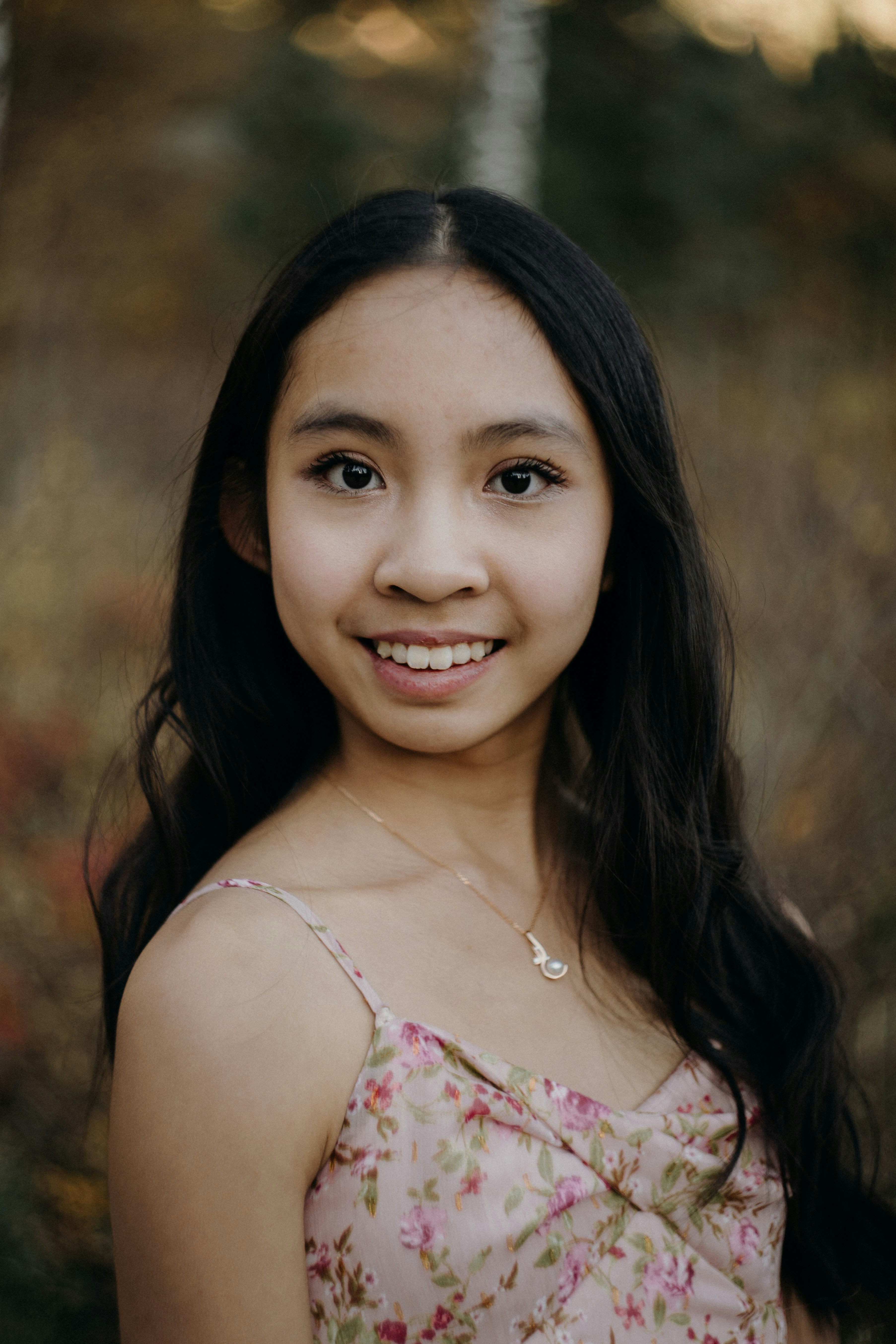 Soft Portrait in Autumn Light: A Friendly Gaze in a Floral Dress