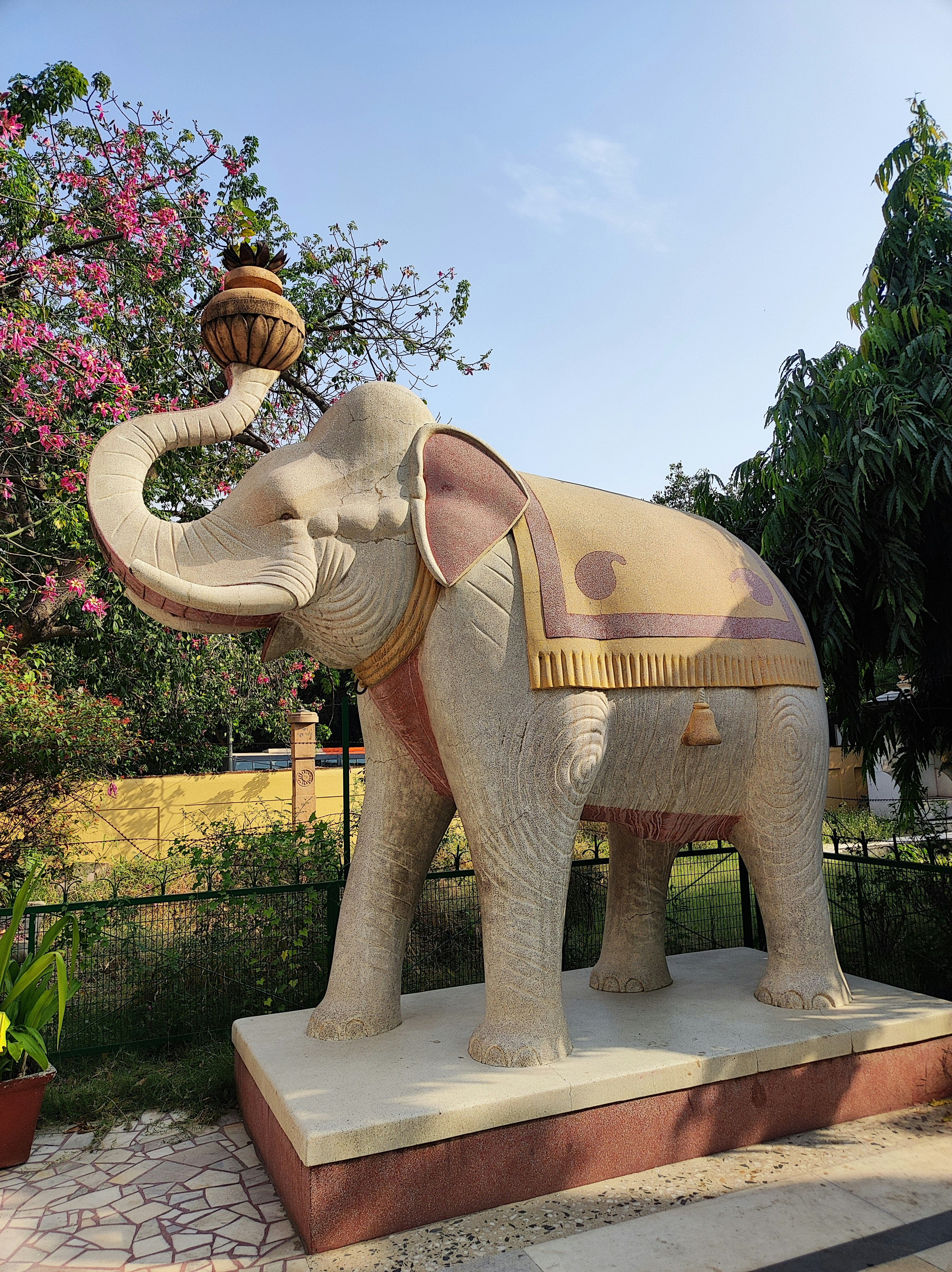 a statue of an elephant with a basket on its back