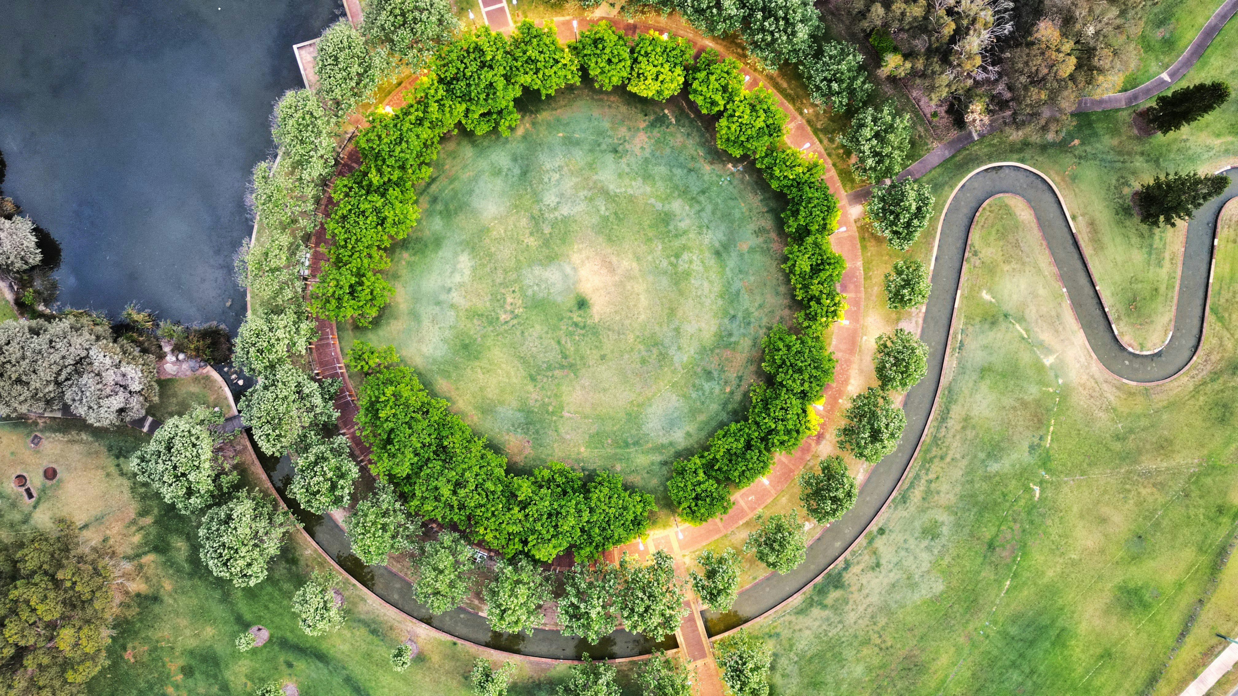 An aerial view of a circular park with a river running through it photo ...