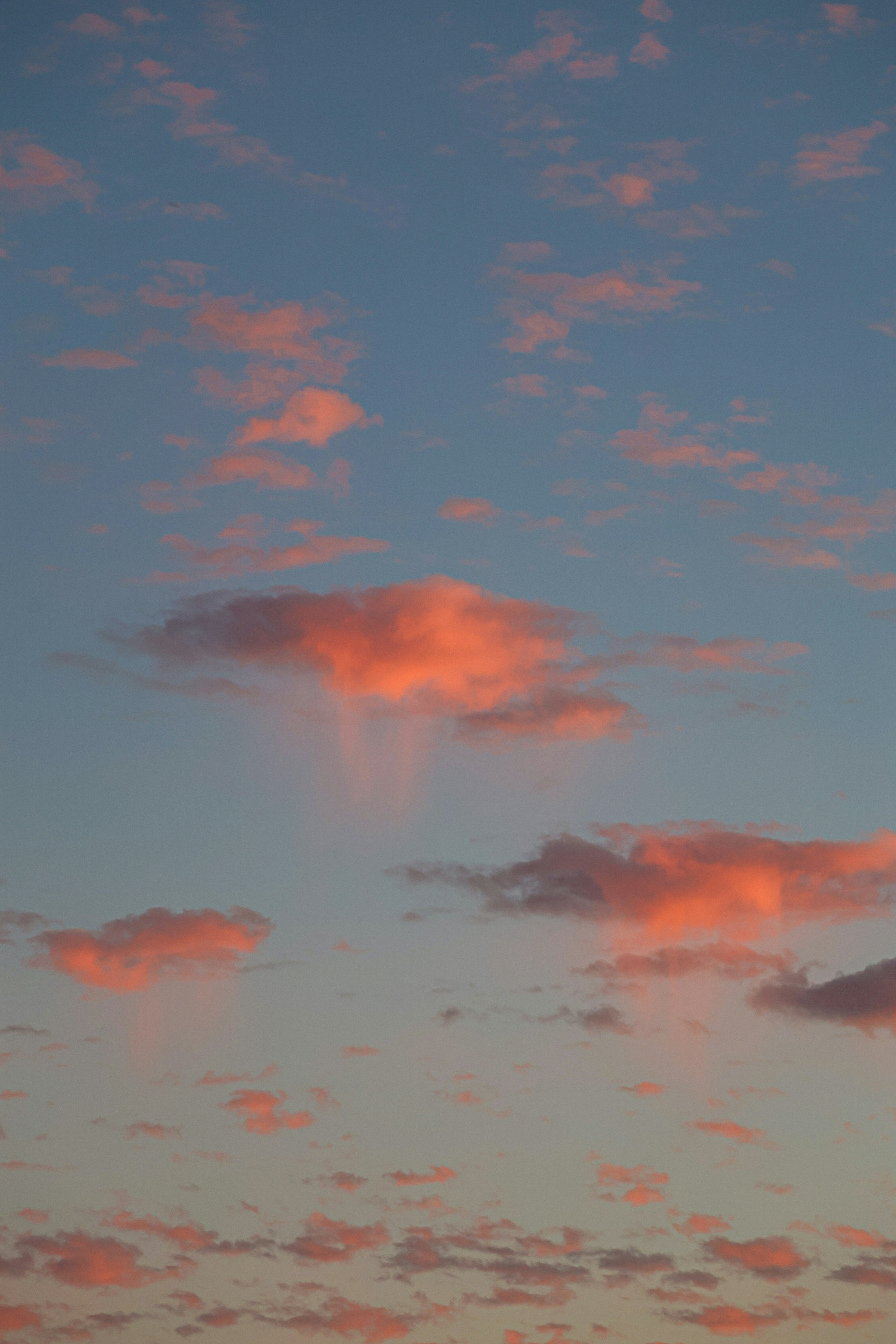 Ember Currents: Orange Clouds Drift Across a Calming Blue Sky