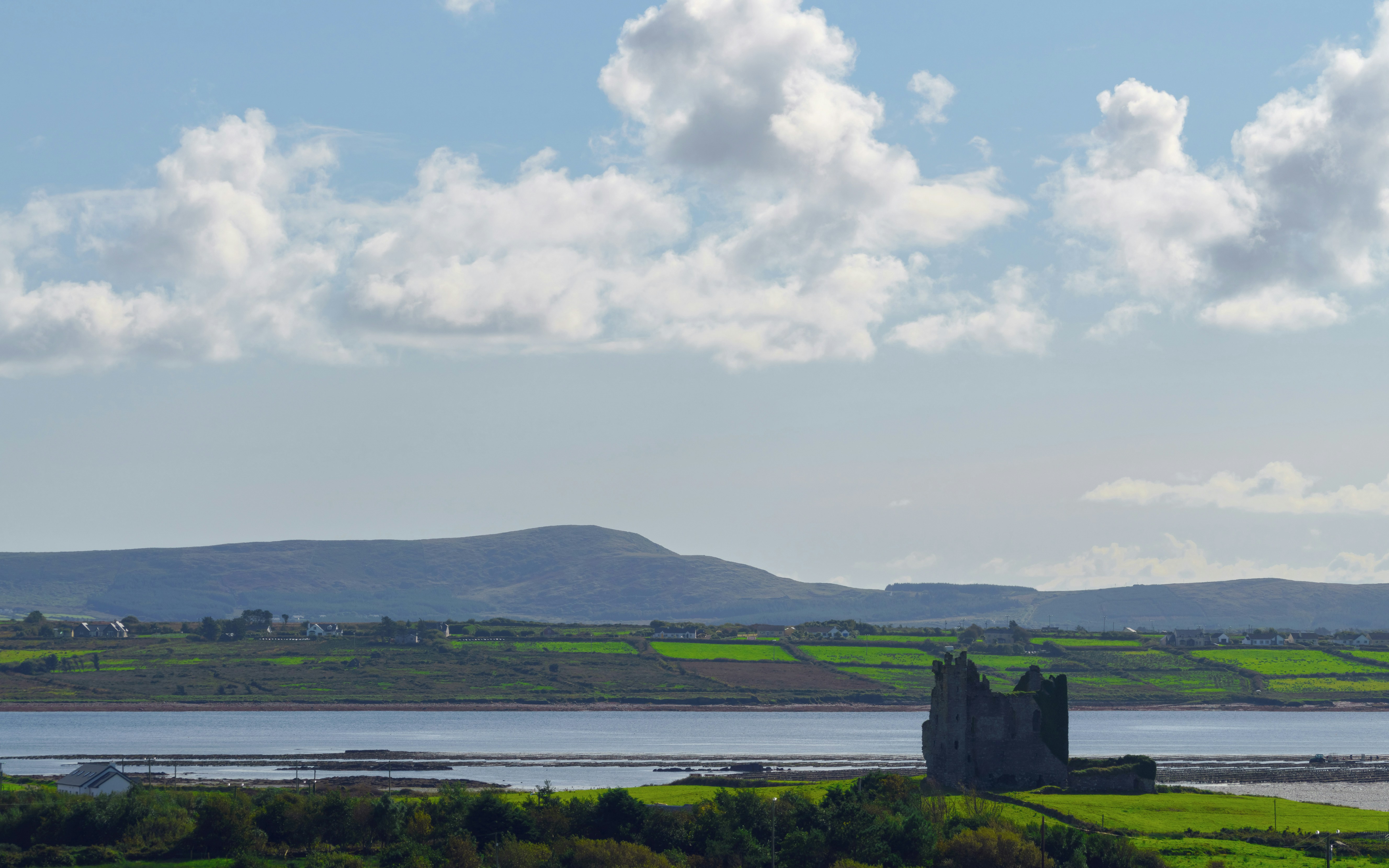 A castle in the middle of a green field photo – Free Ireland Image on ...