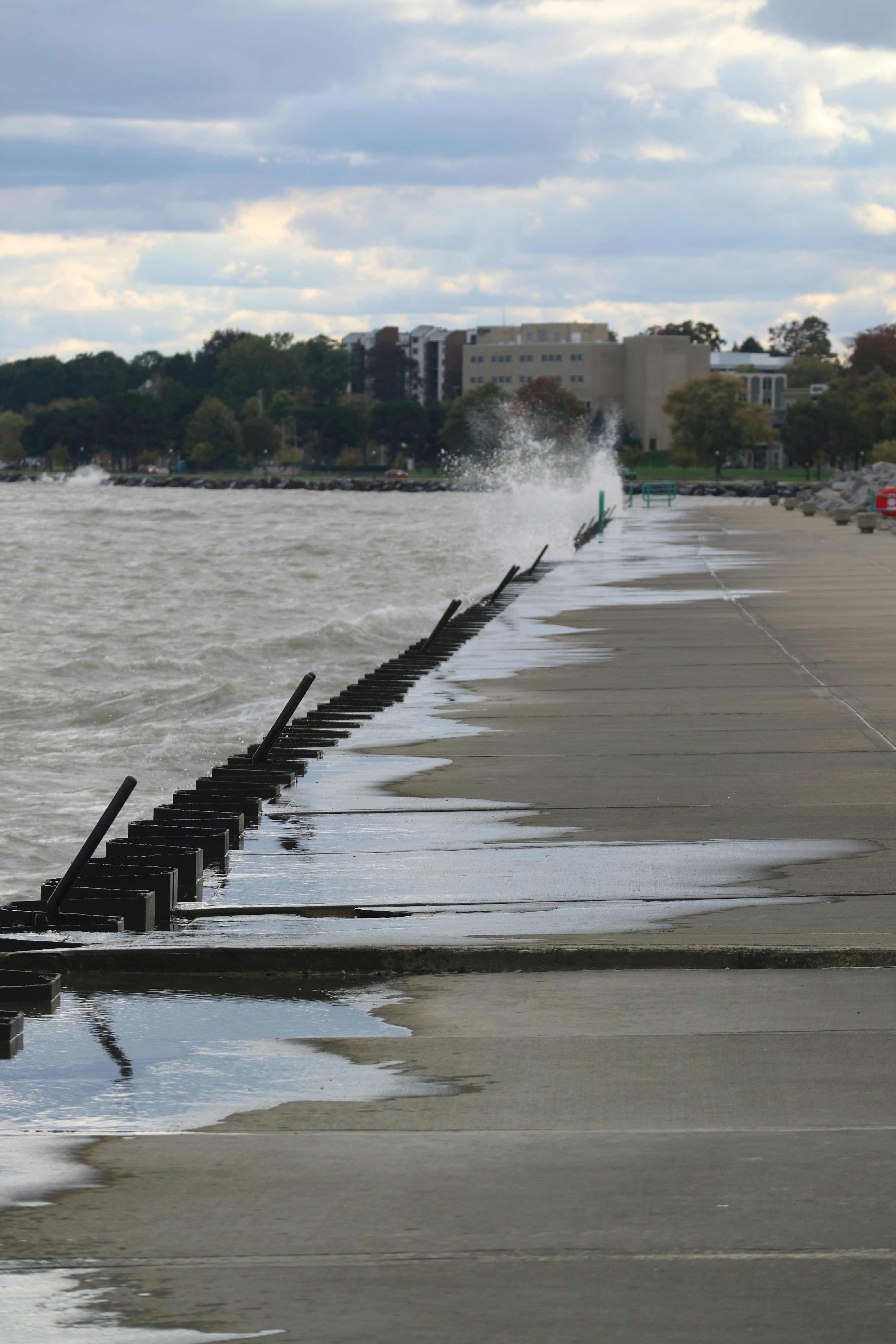 Jetty Spritz: Studded posts line a lakeside promenade as waves crash near the far end