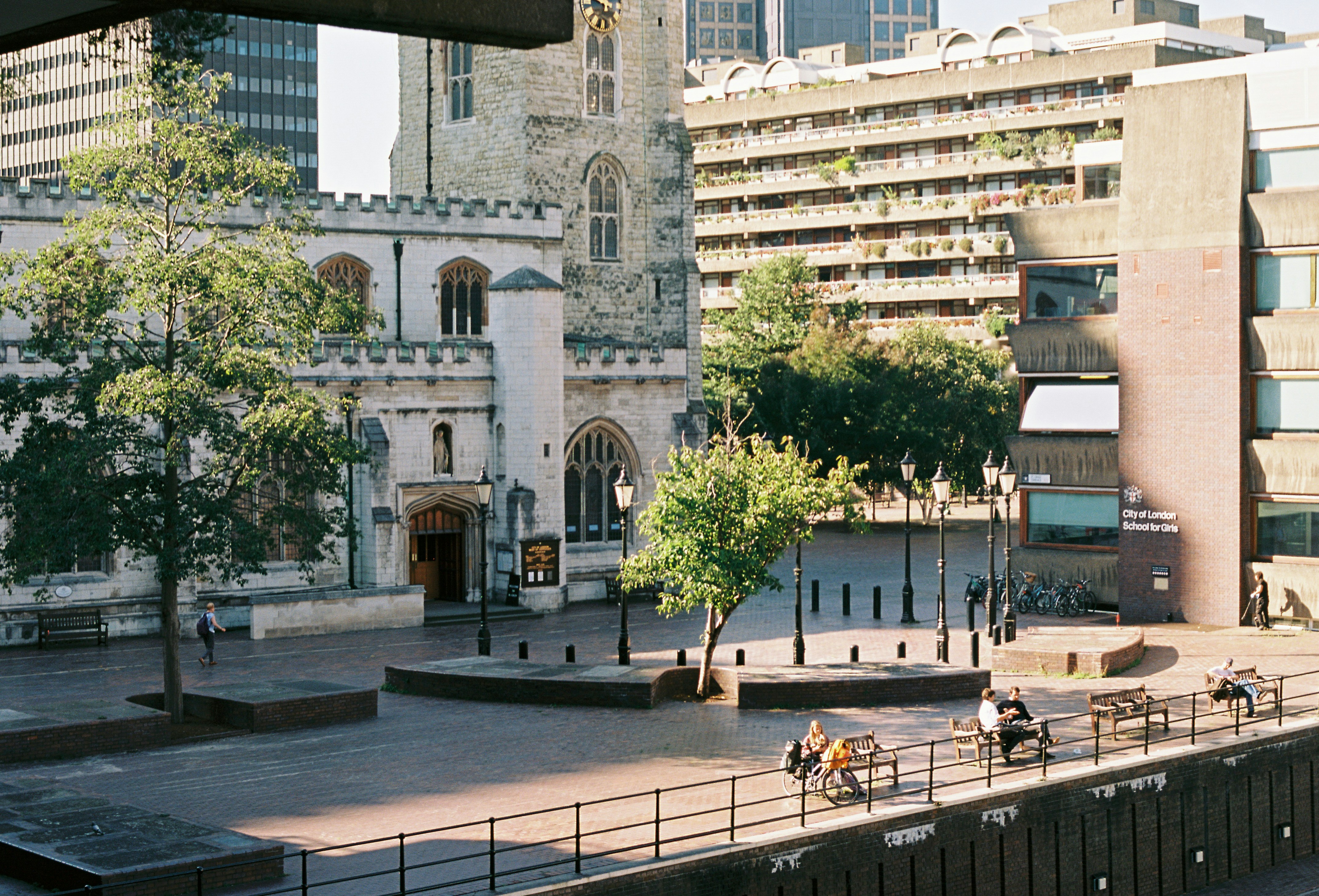 A group of people walking around a city square photo – Free London ...
