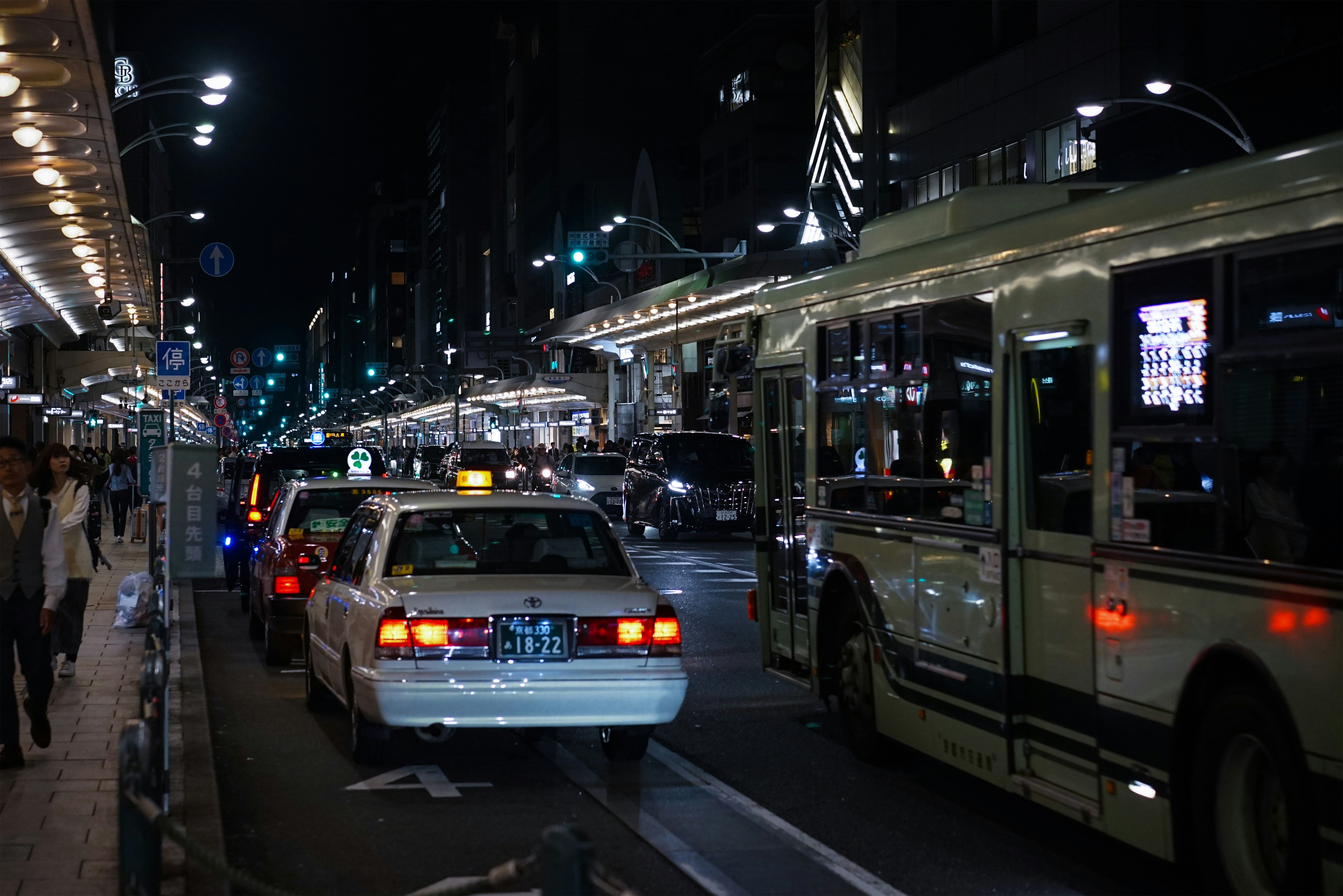 A busy city street at night with cars and buses photo – Free Kyoto ...