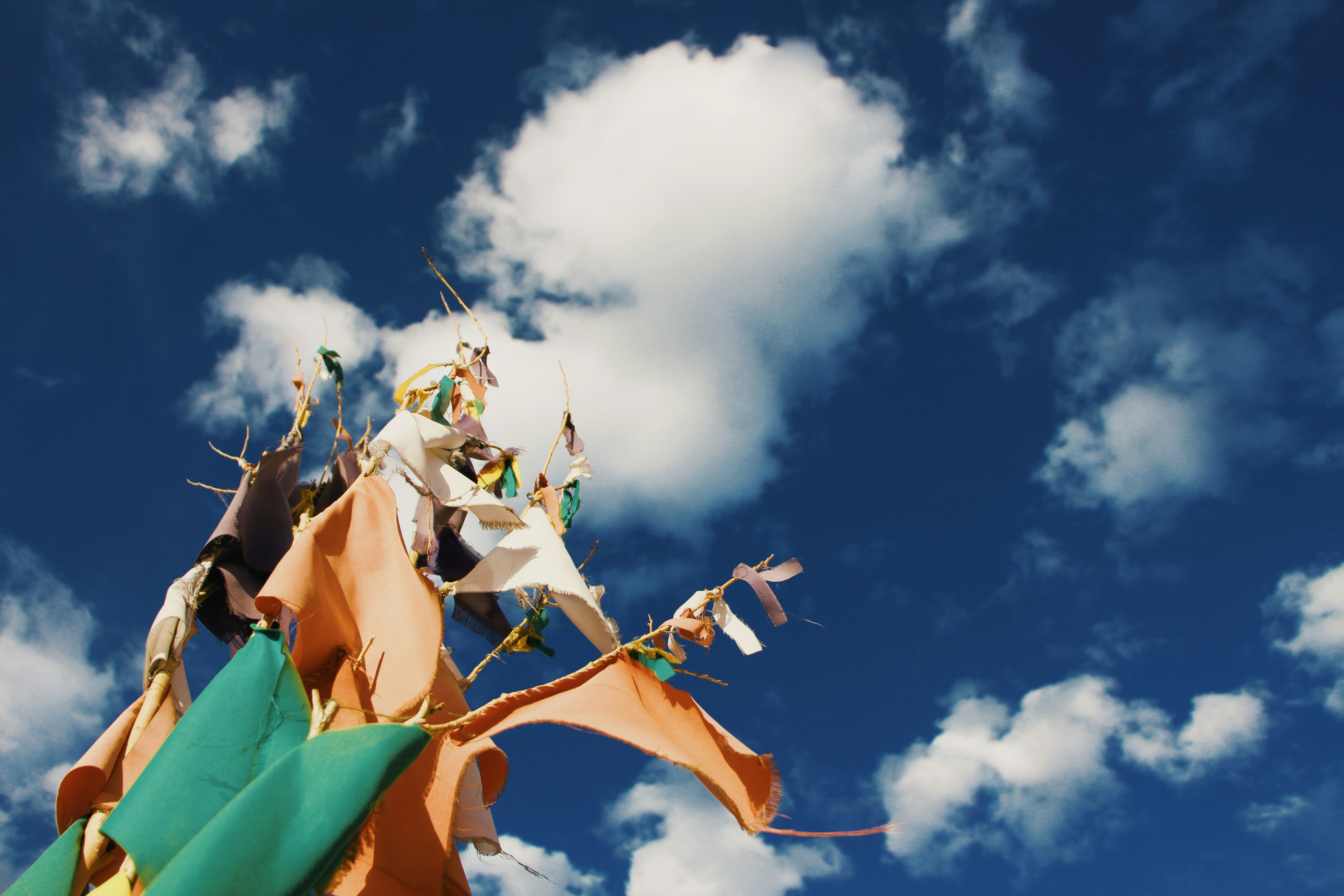 A kite flying in the sky with clouds in the background photo – Free ...