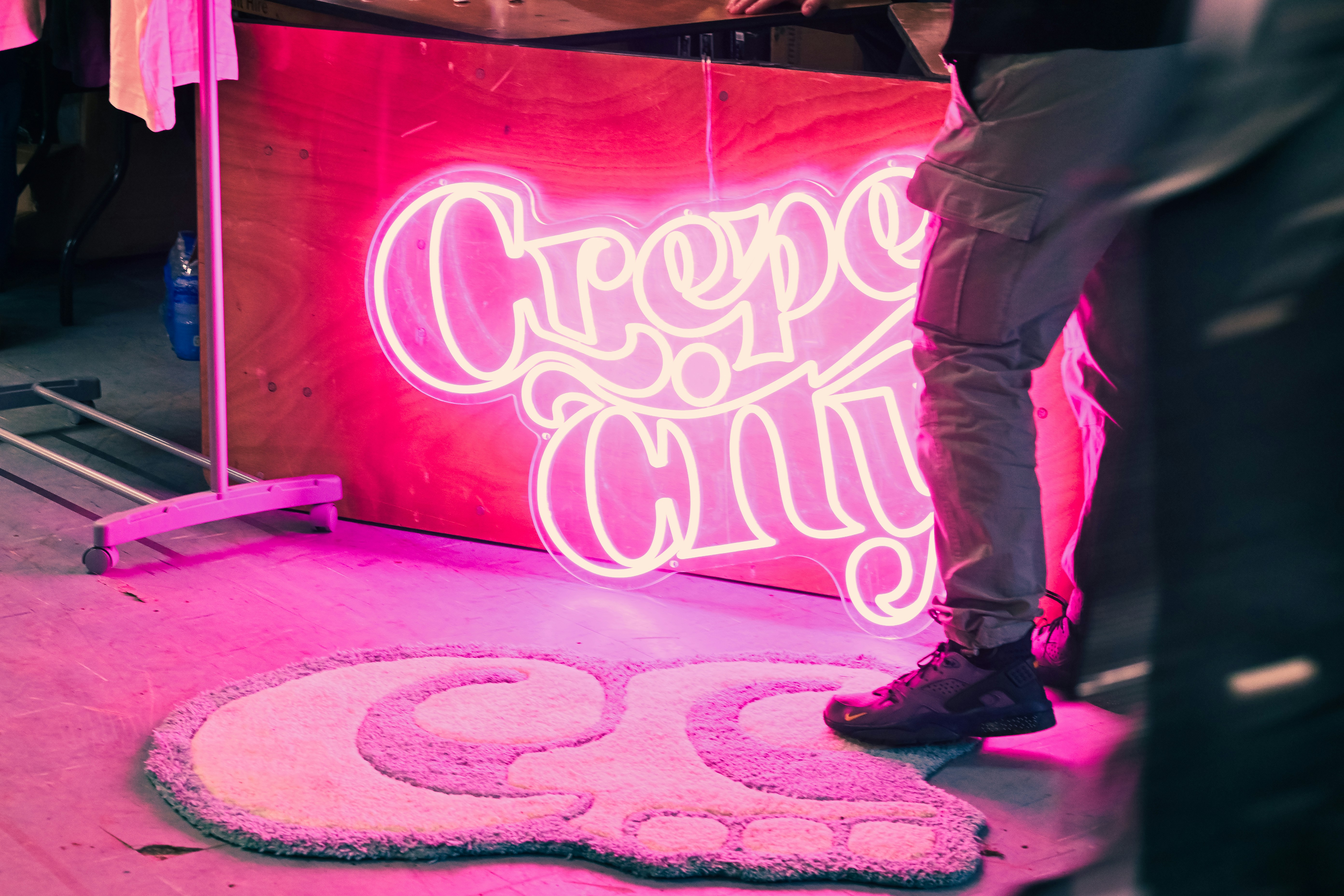 Neon Crepe Glow: Pink Spotlight on a Quiet Street Stand