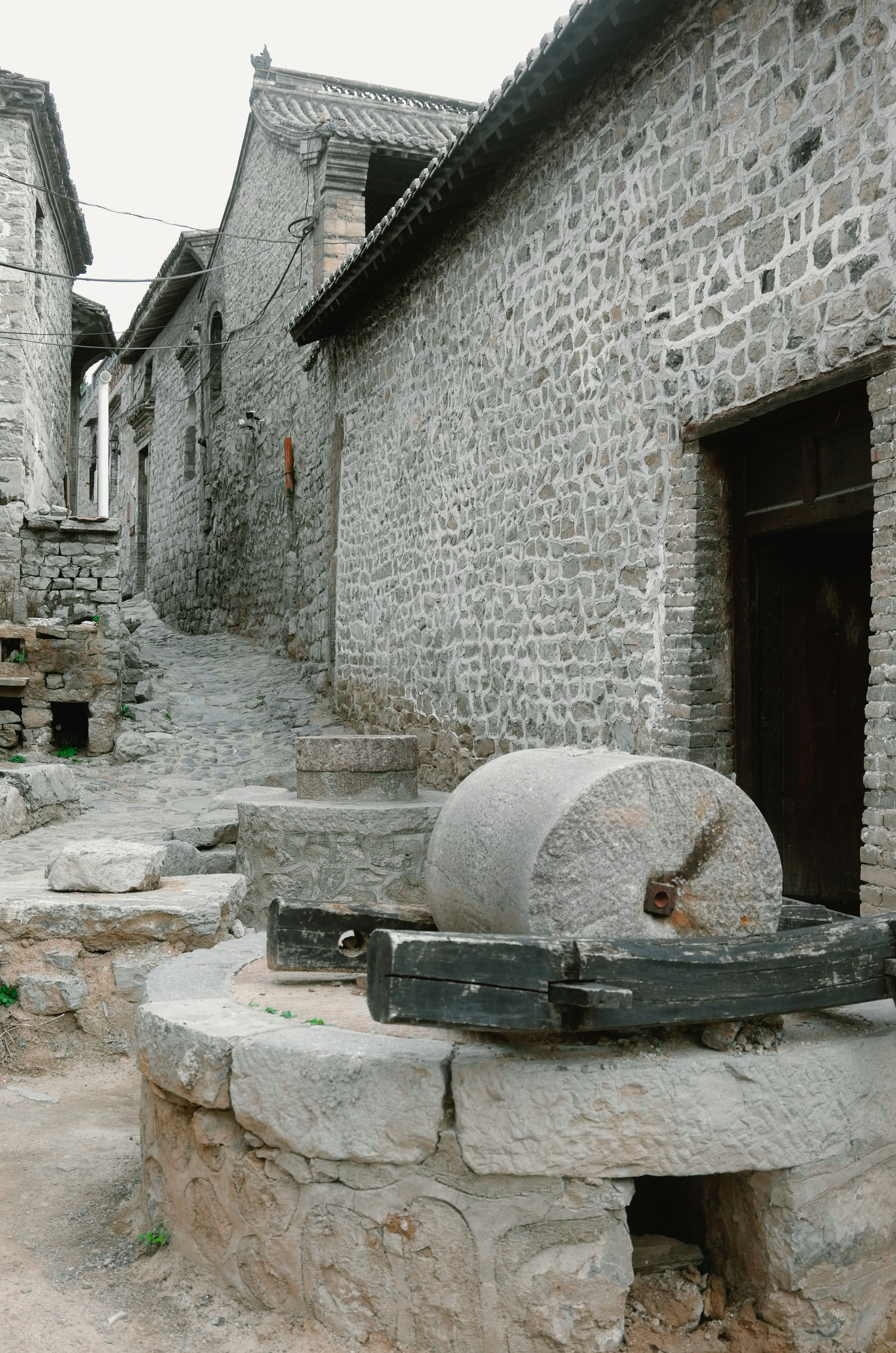 A stone building with a large object on the ground photo – Free ...