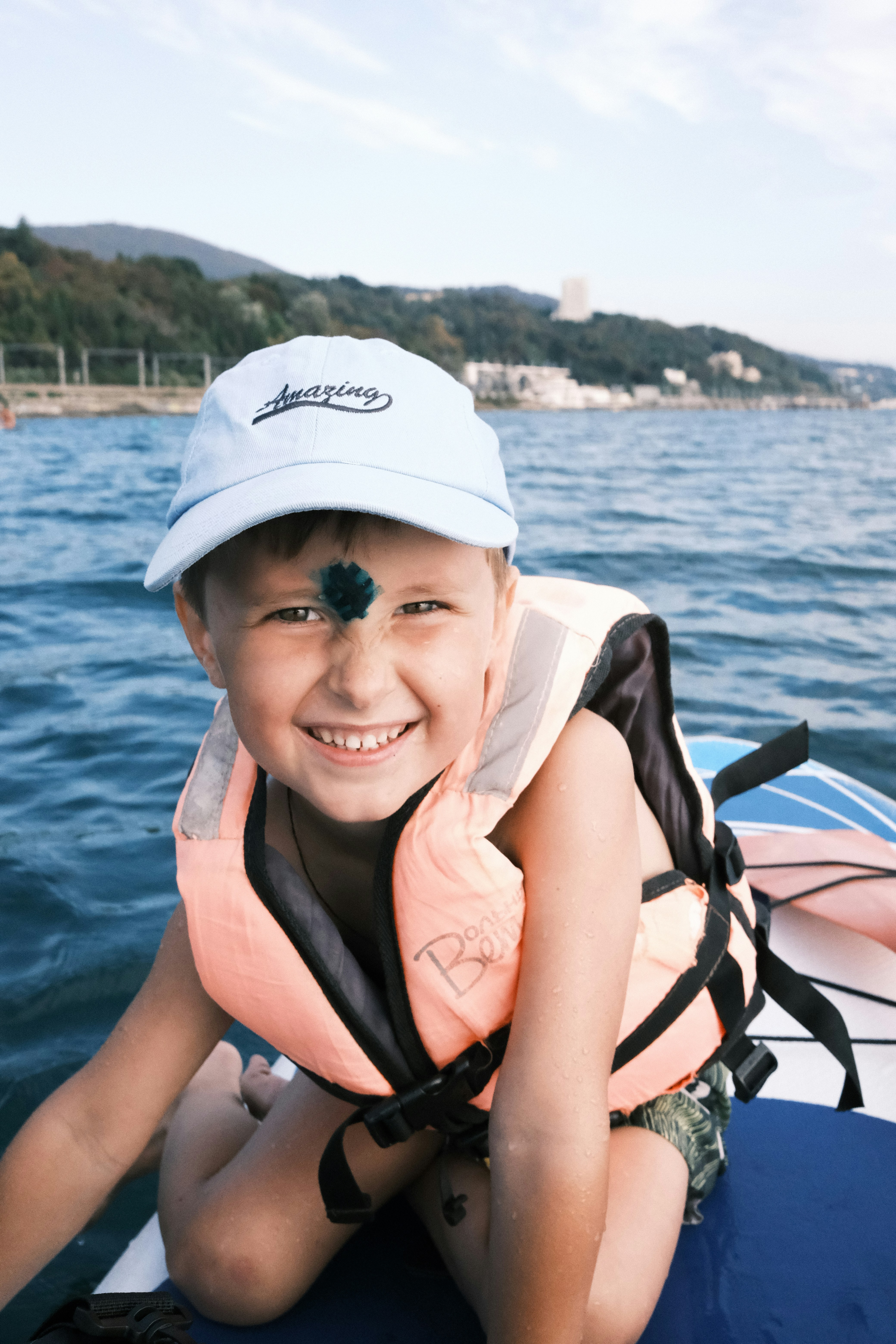 Pocket-Sized Captain Smiles Across Blue Waters