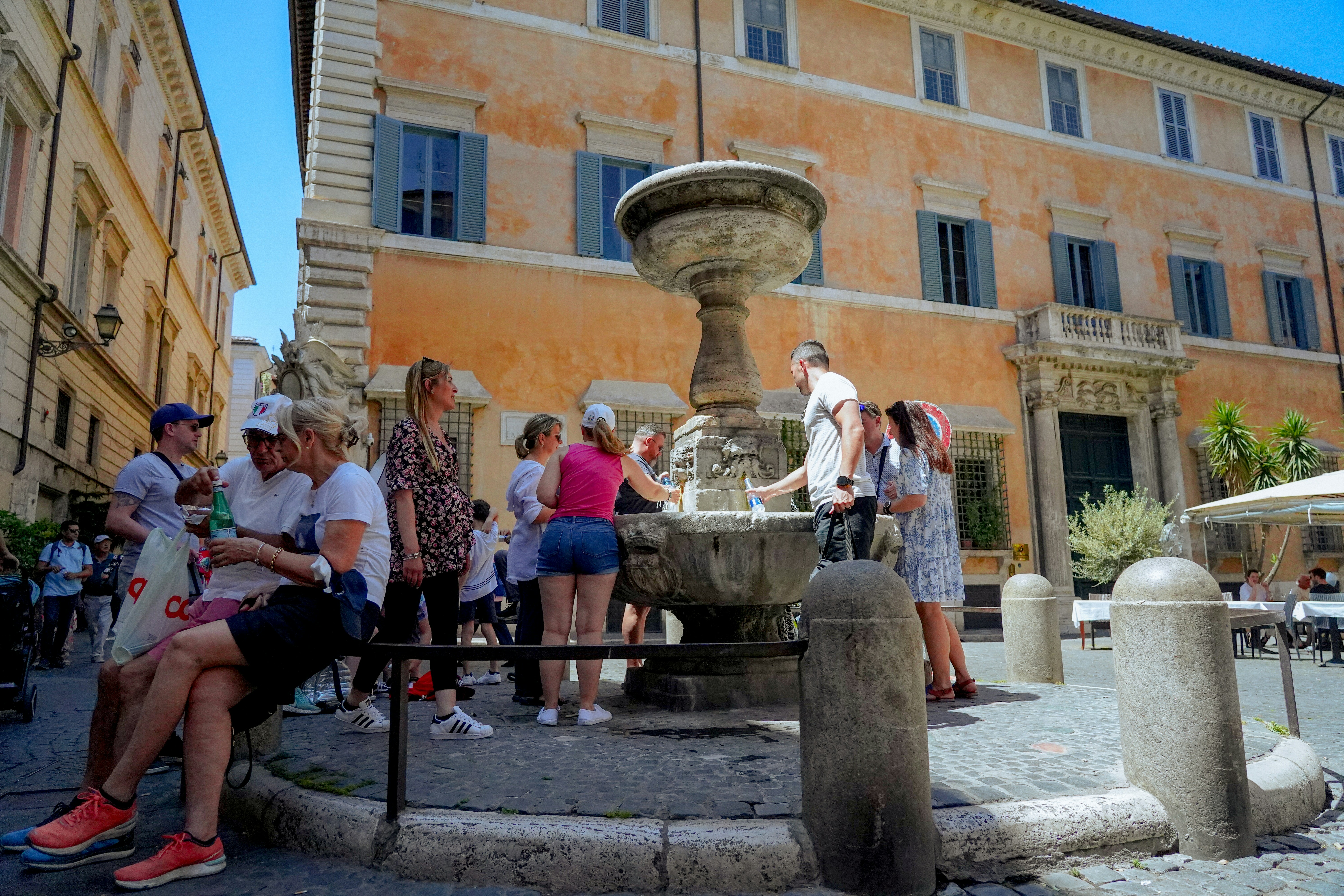 Courtyard Crowd at a Sunlit Italian Fountain