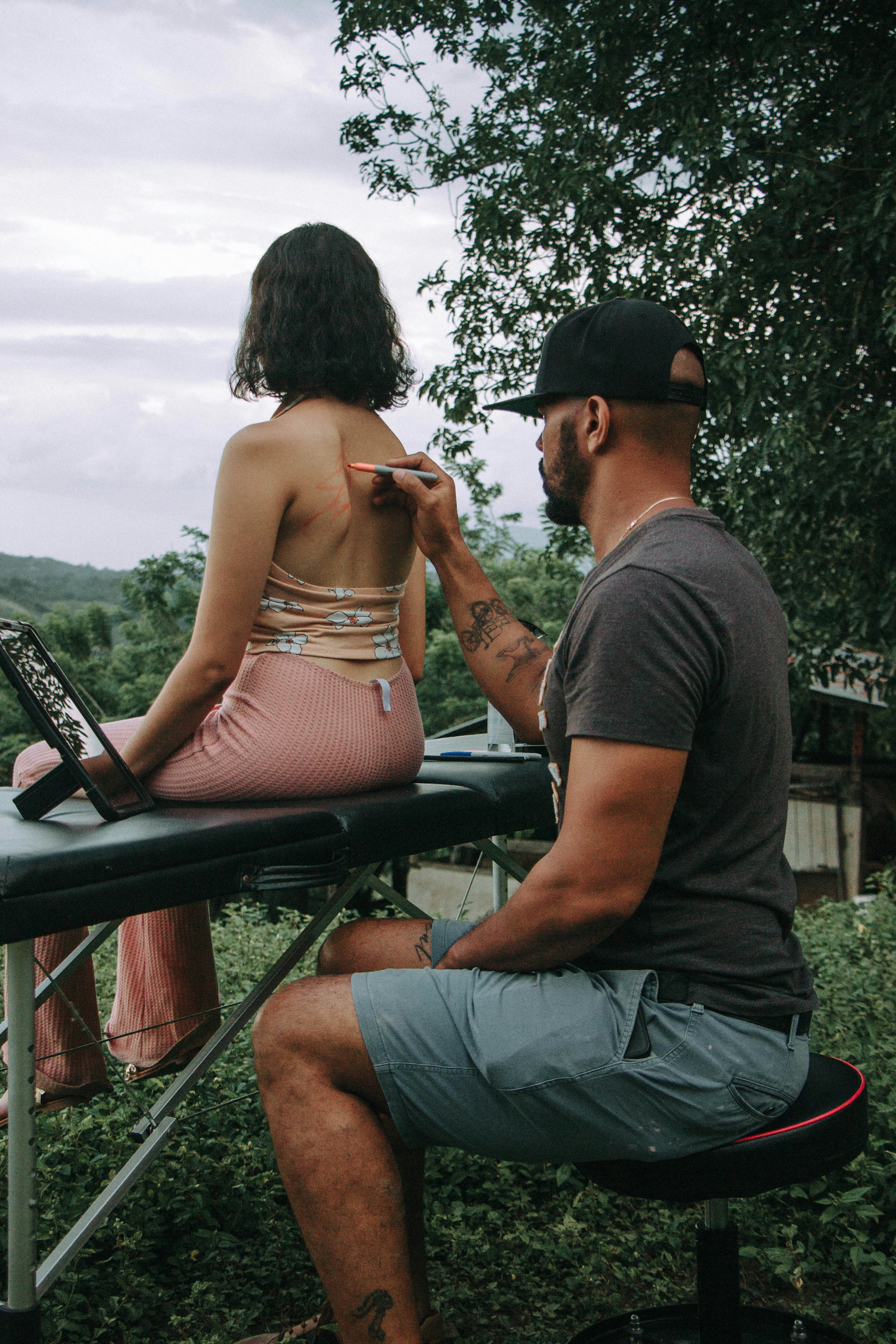 Backlit Portrait Session: Tattooed Artist Finishes Details on an Outdoor Stretch