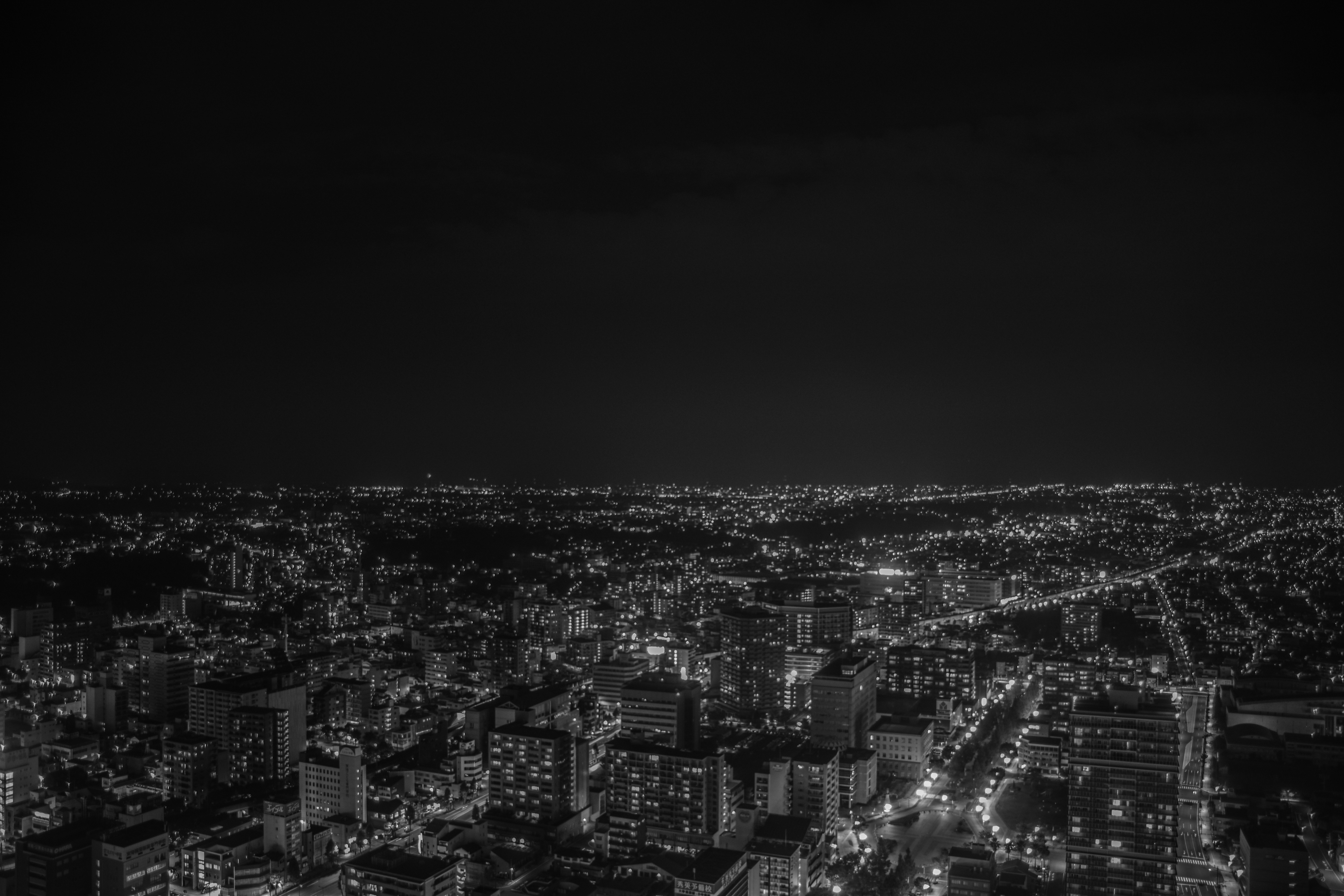 a black and white photo of a city at night