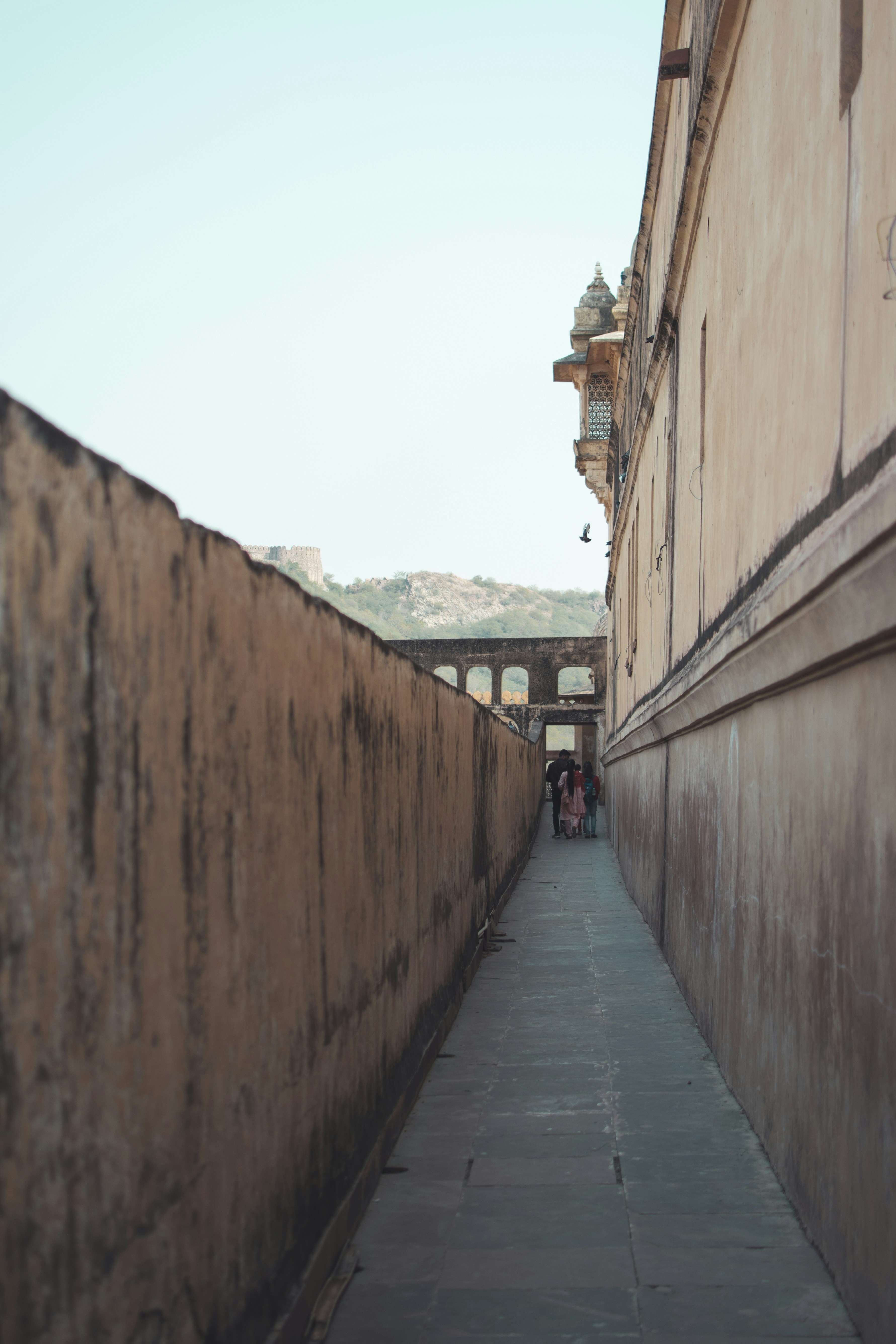 Path of Light Through a Narrow Fortress Corridor Toward an Arch