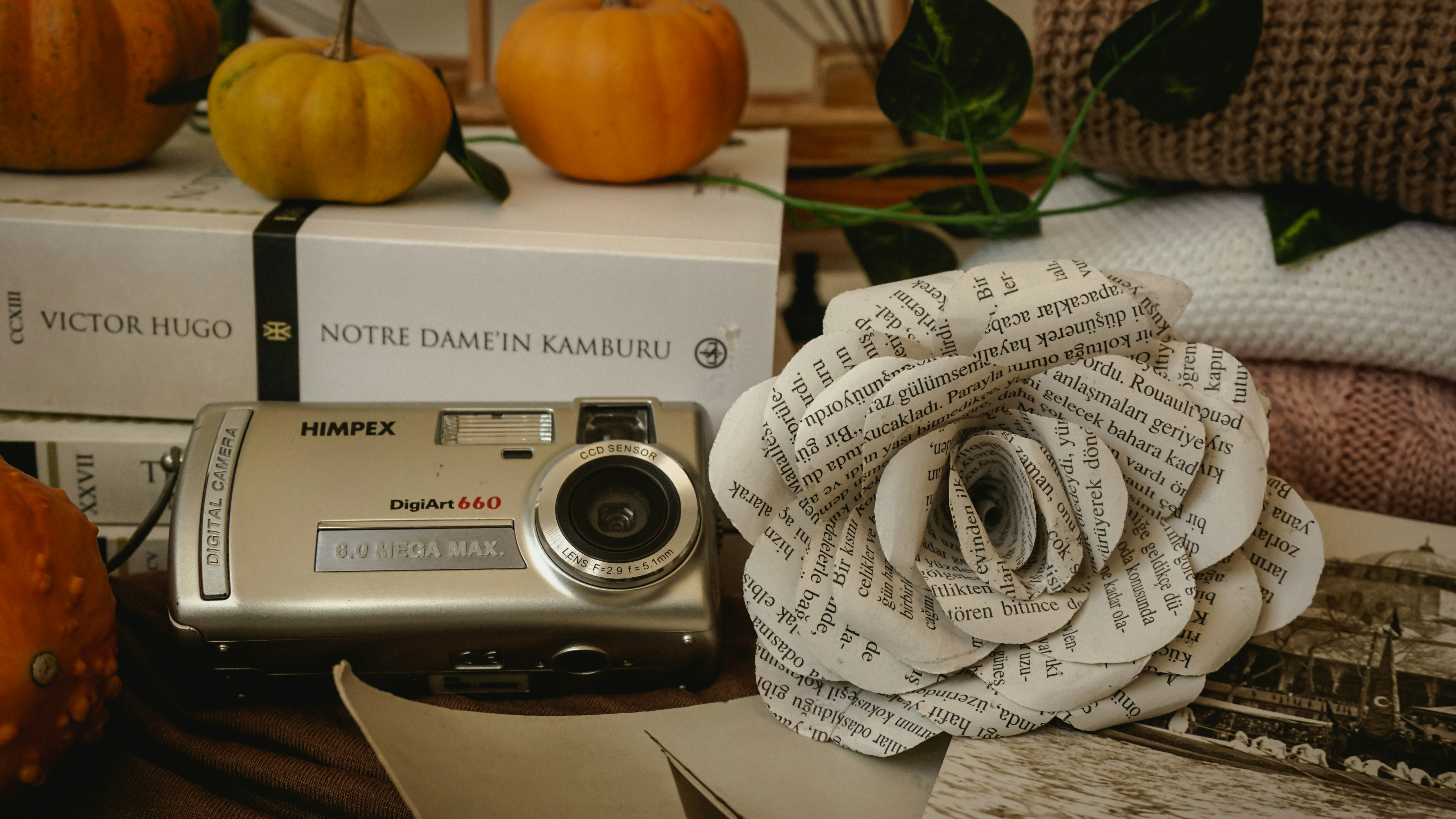 a camera sitting on top of a pile of books
