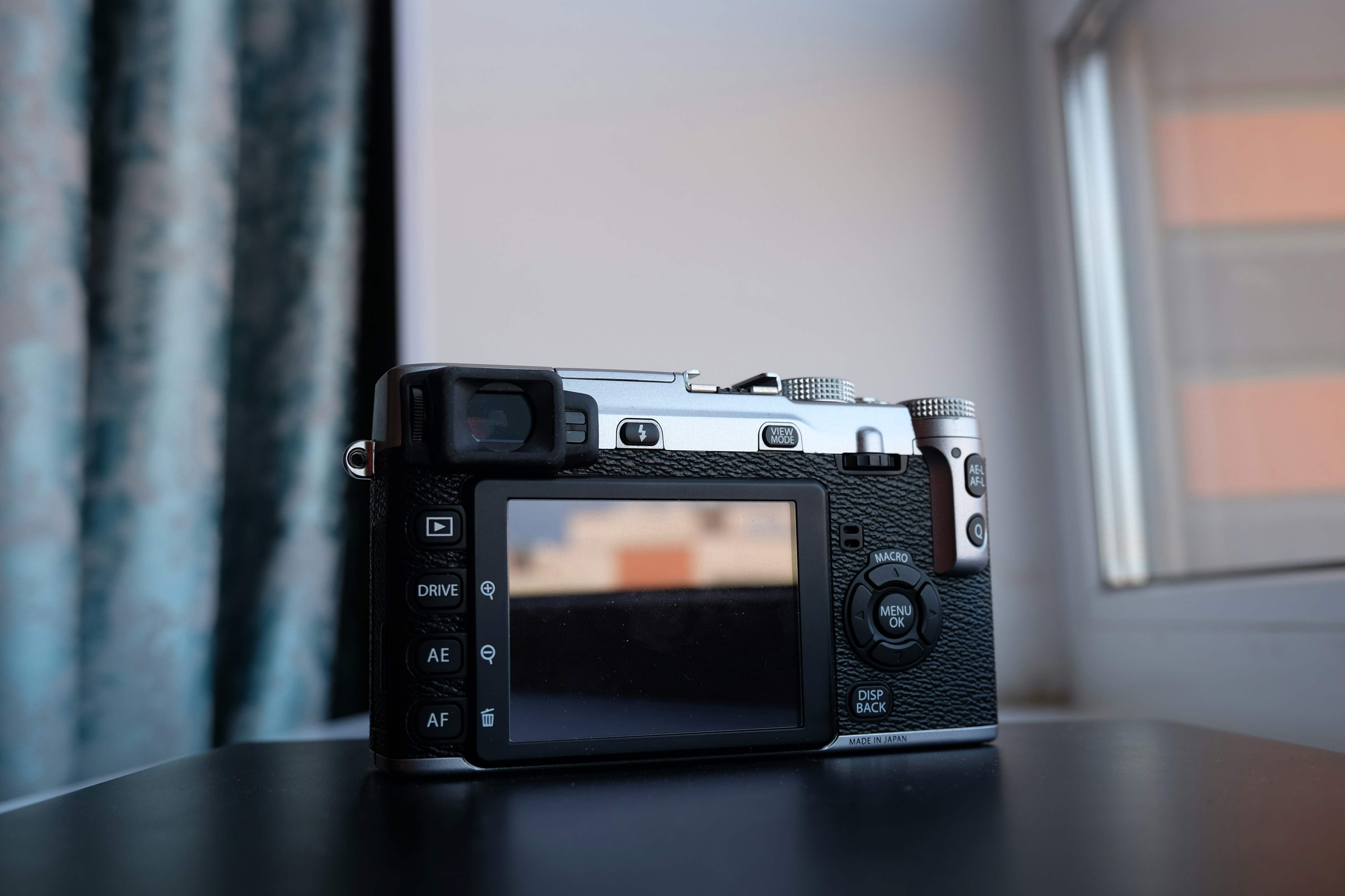Backside of a Classic: A Fujifilm X-E2 Basking in Window Light on a Quiet Desk