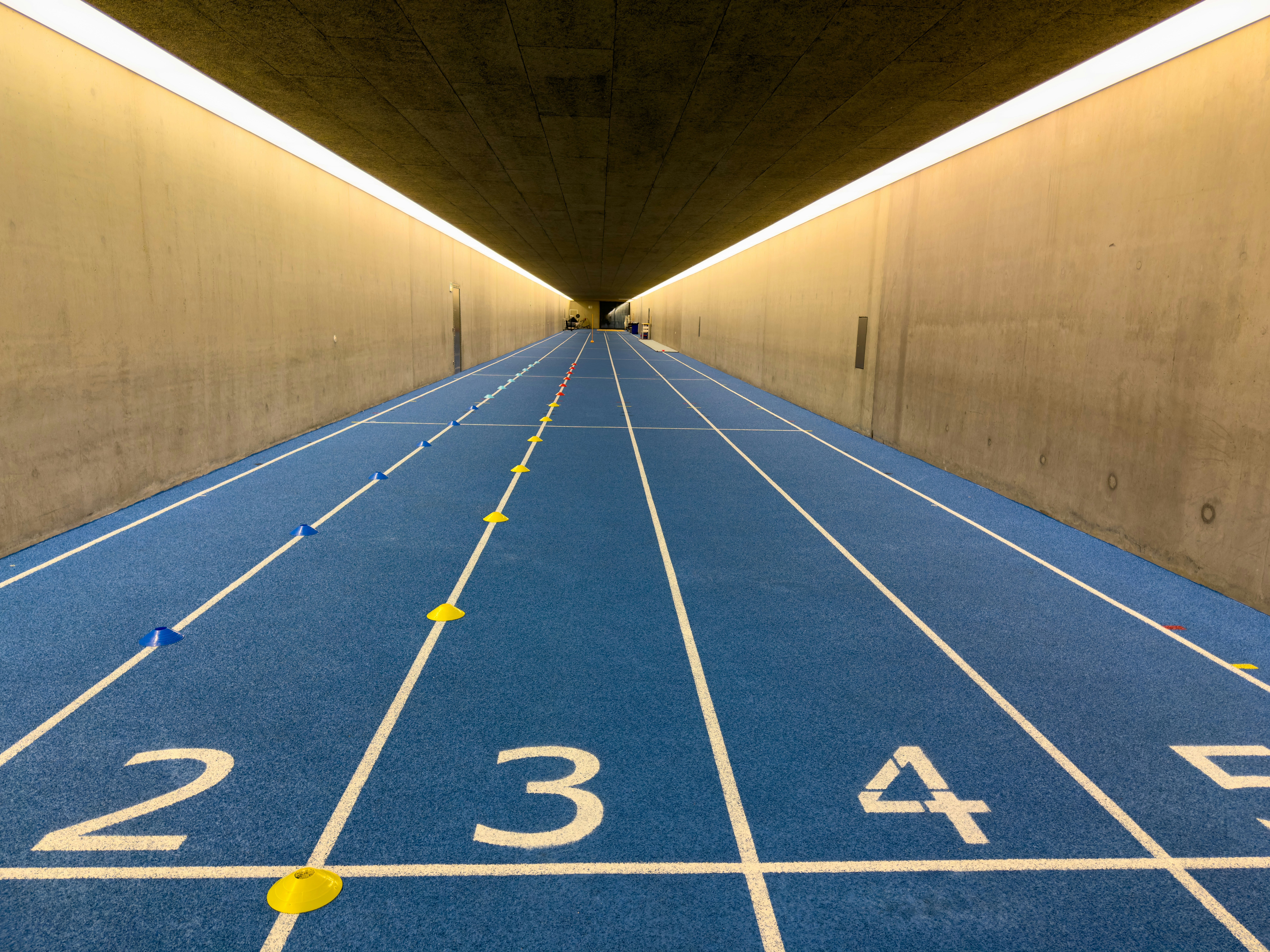 A blue running track with numbers painted on it photo – Free Zürich ...