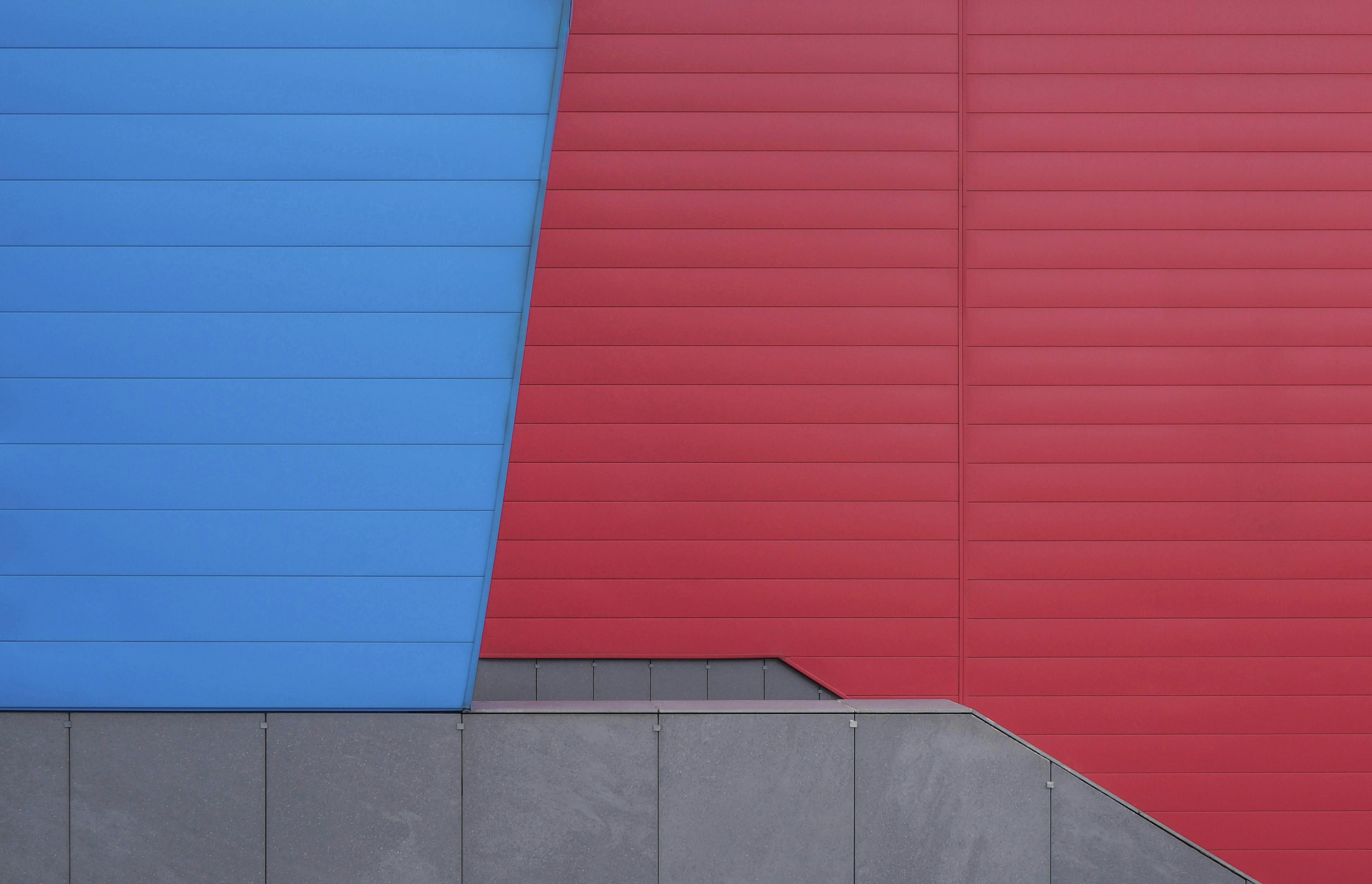A red and a blue building side by side photo – Free Wall Image on Unsplash