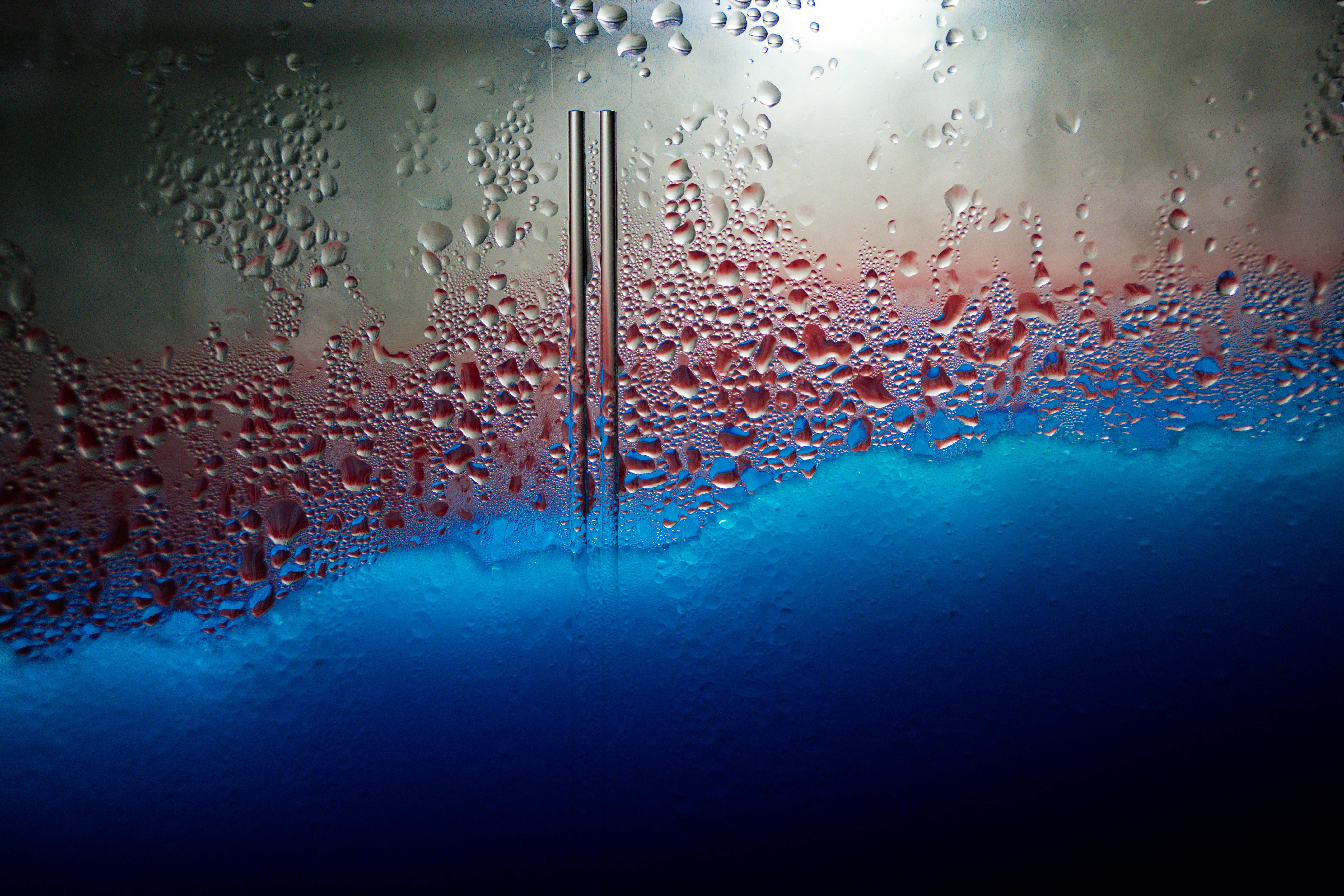 Condensation Glyphs: Light-Touched Droplets on a Glass Curtain
