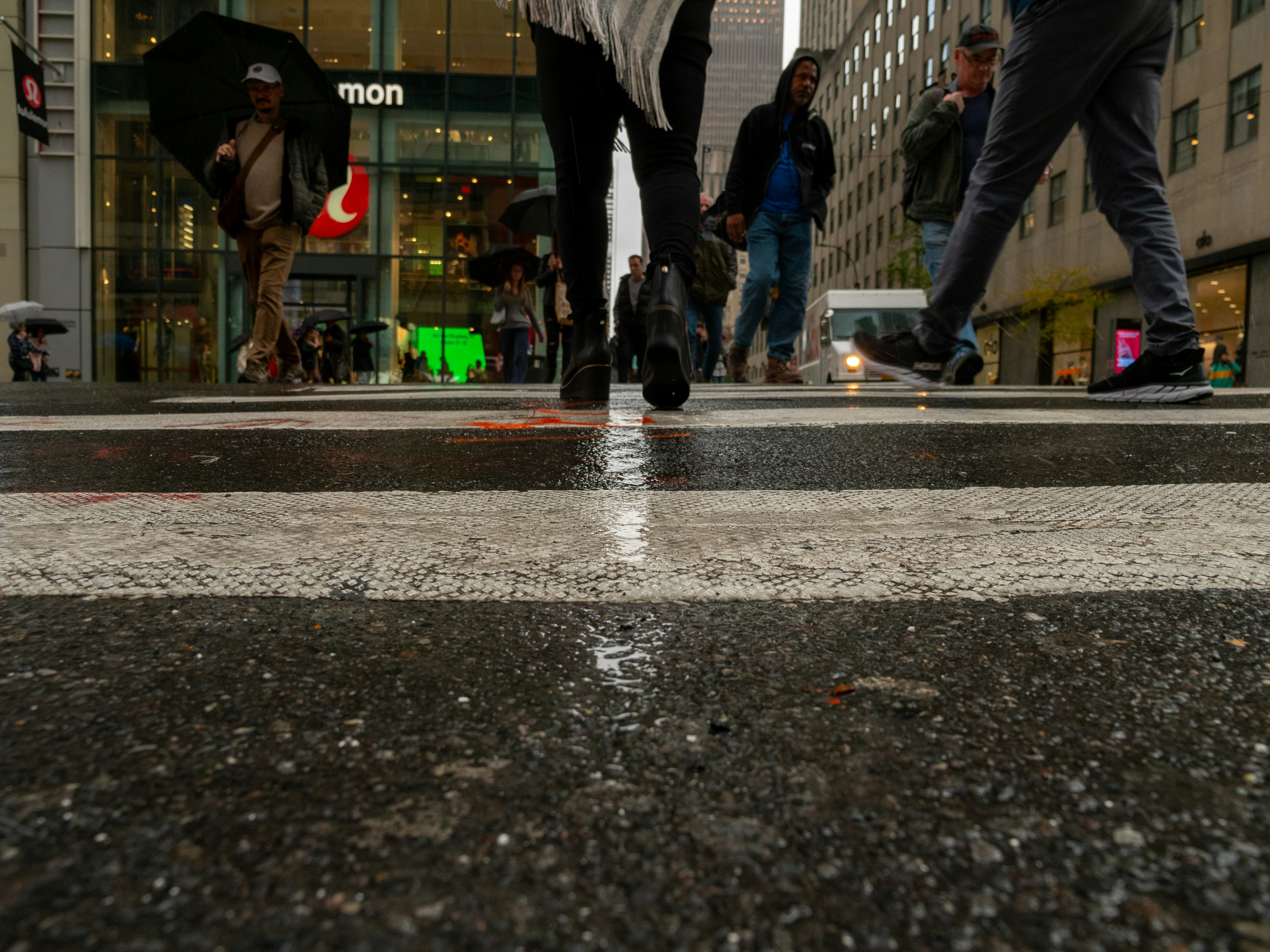 Ground-Level Pulse: Feet and Reflections on a Rainy City Crosswalk
