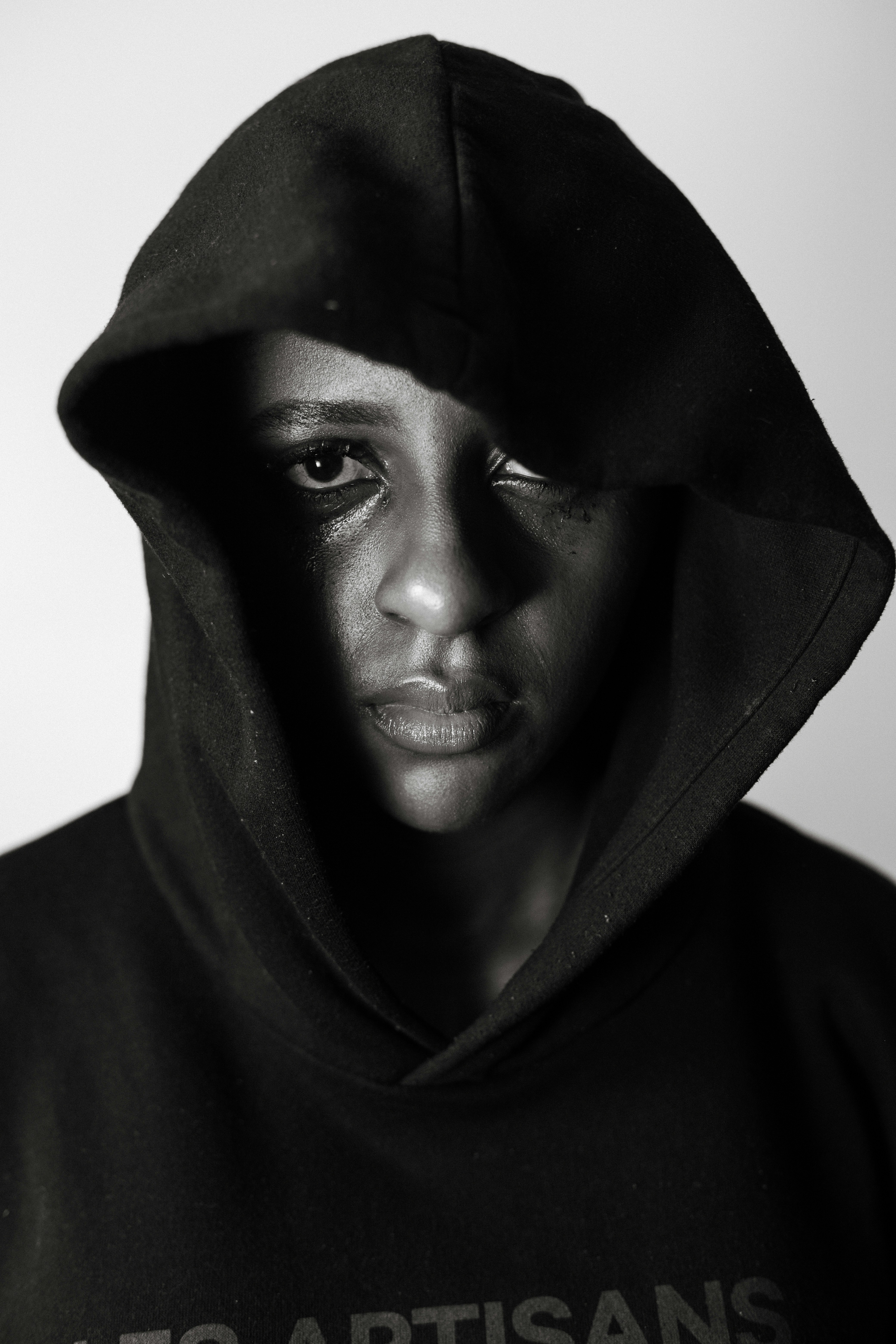 Direct Gaze Beneath the Hood: A High-Contrast Black-and-White Portrait