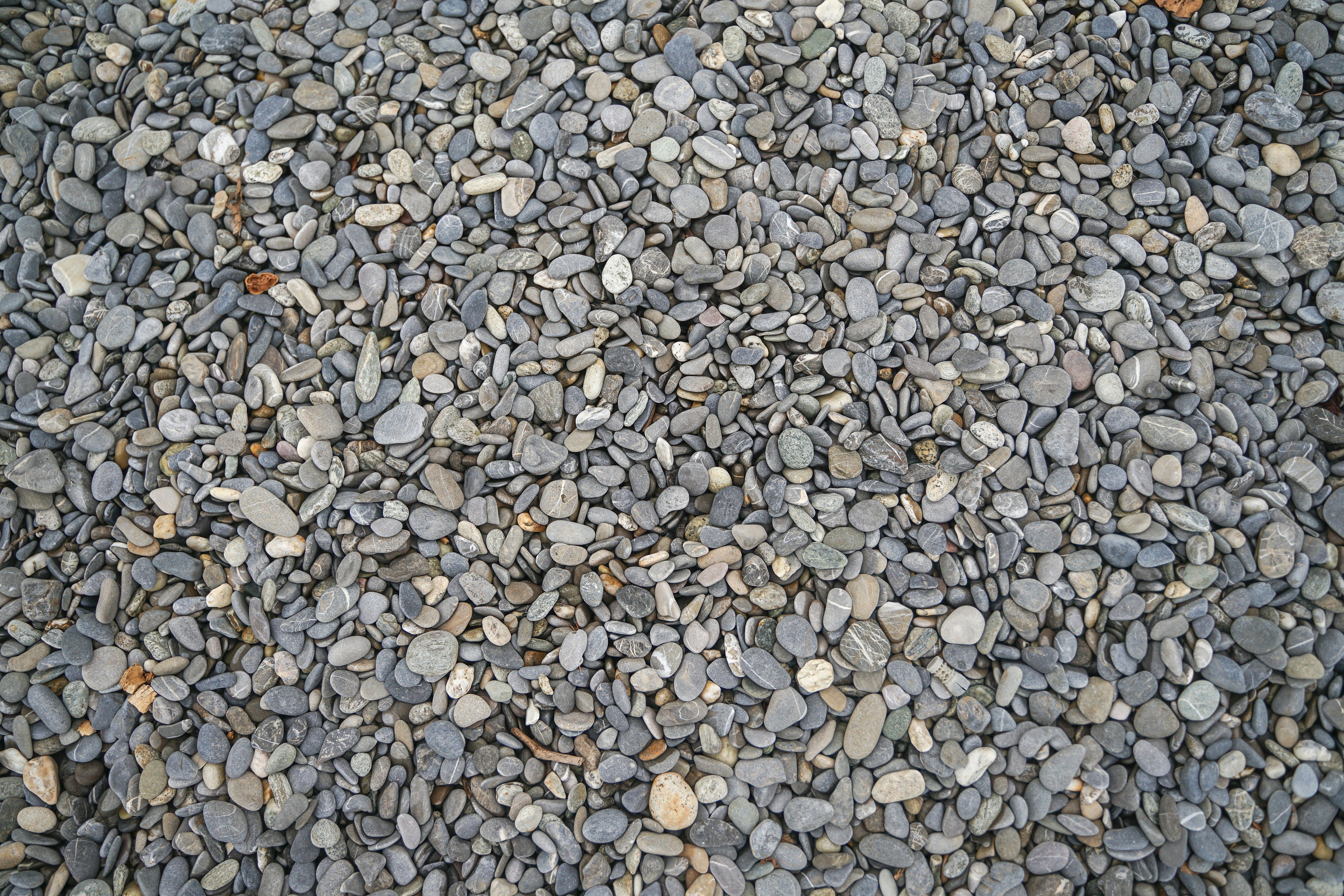 A bunch of rocks that are laying on the ground photo – Free Gravel ...