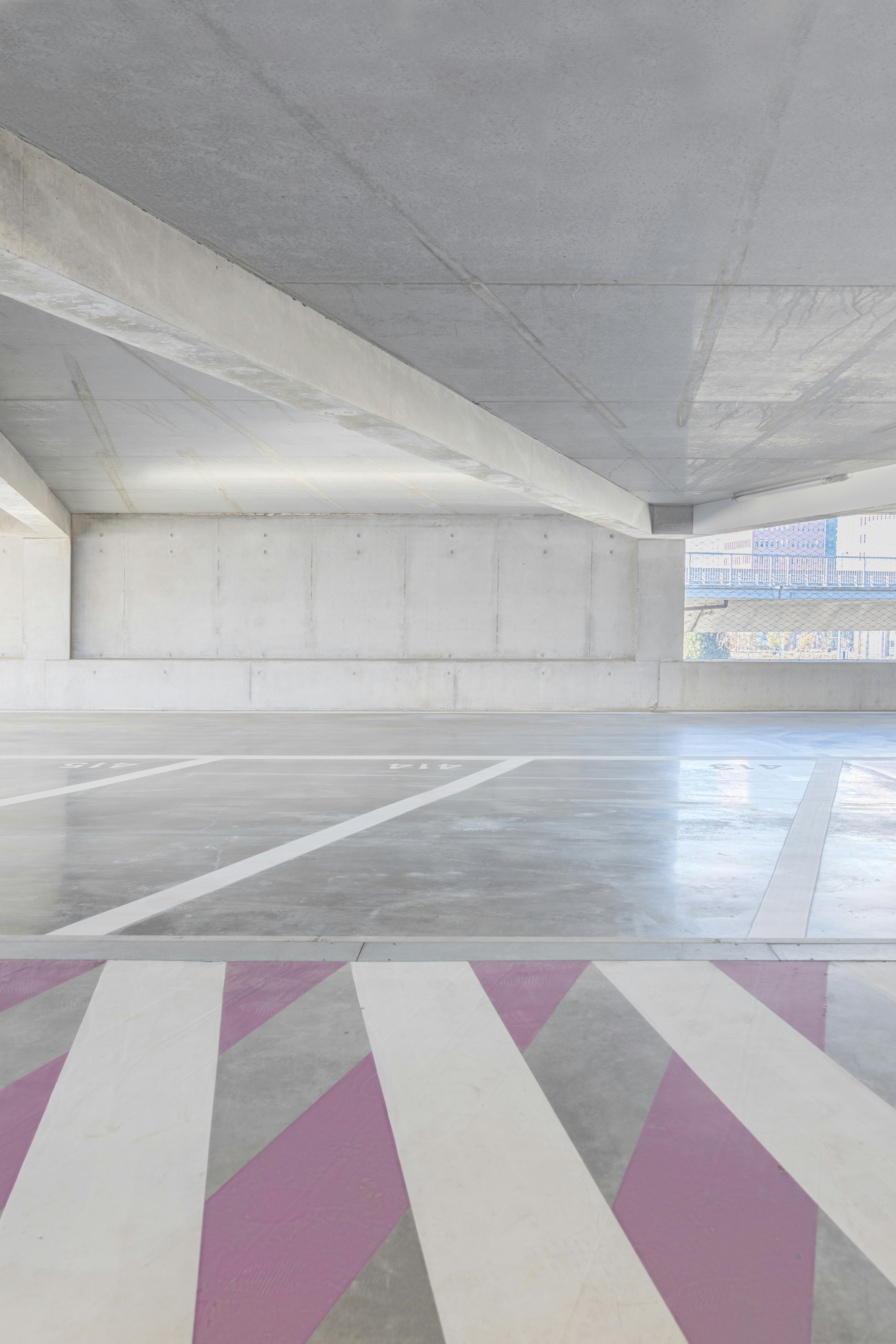 An empty parking garage with pink and white stripes photo – Free Grey ...