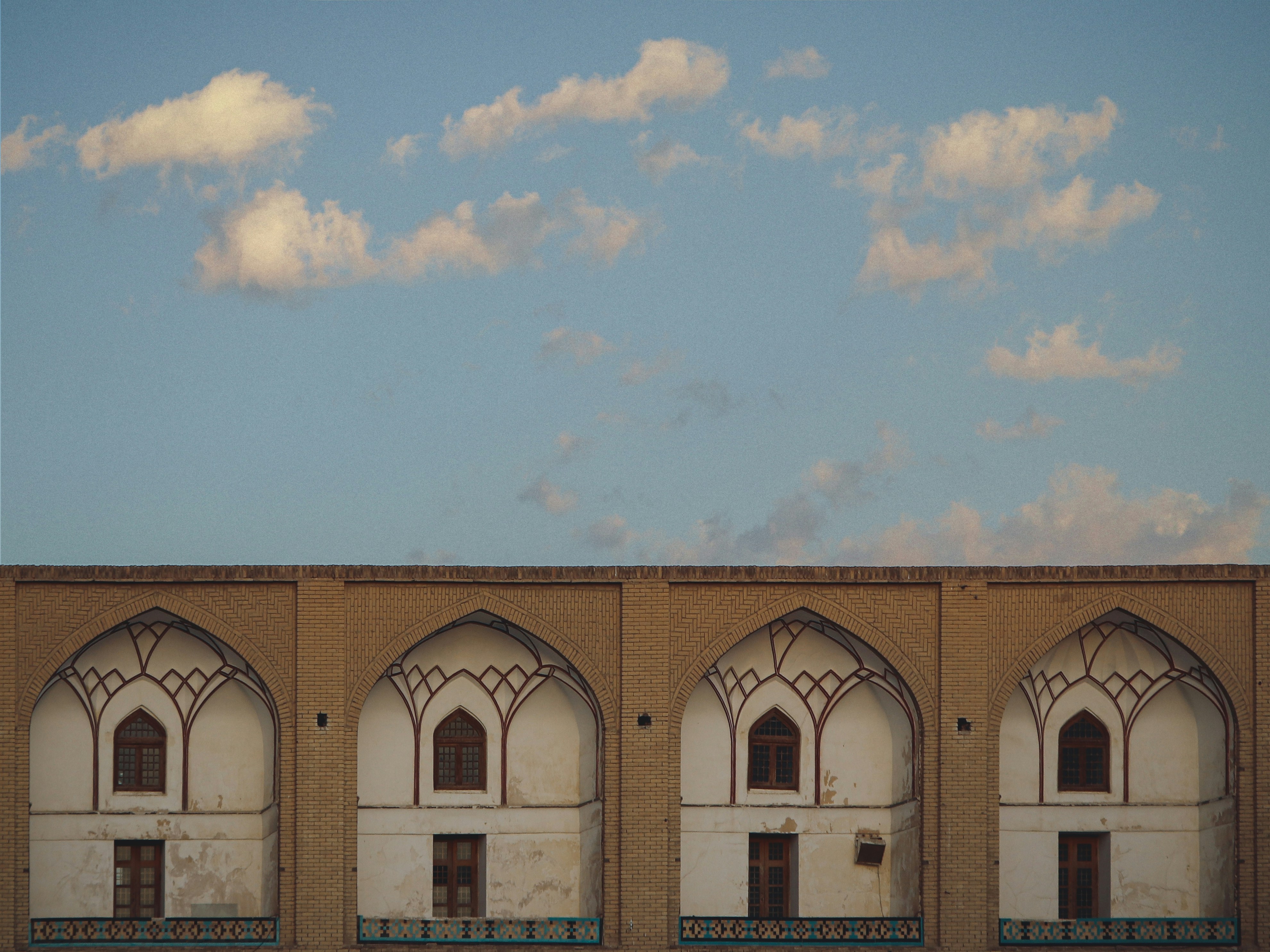 Arched Facade Repetition Under a Quiet Sky