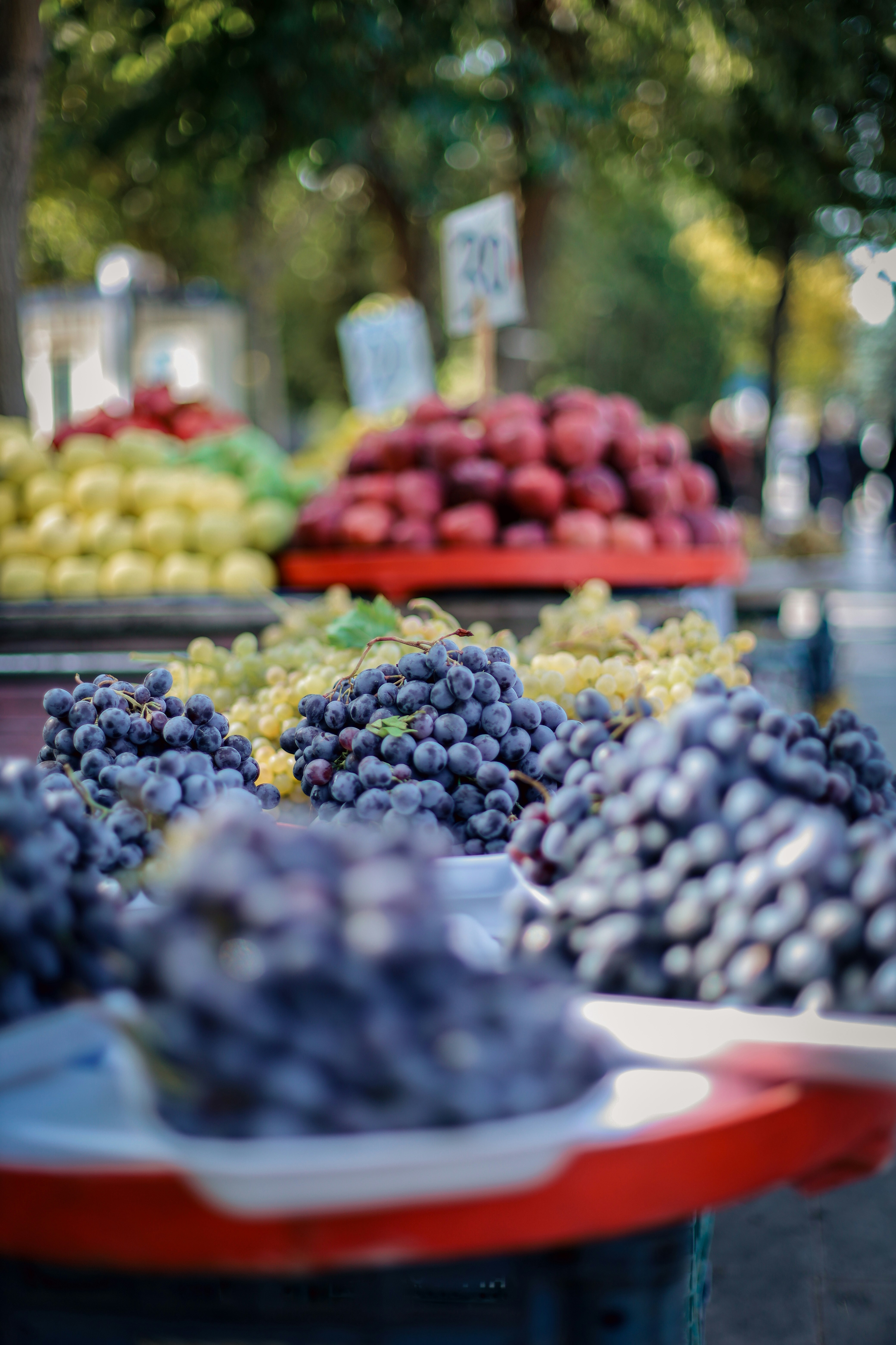 Vibrant Market Bounty: Grapes in the Foreground, Bokeh of Stacks in the Background