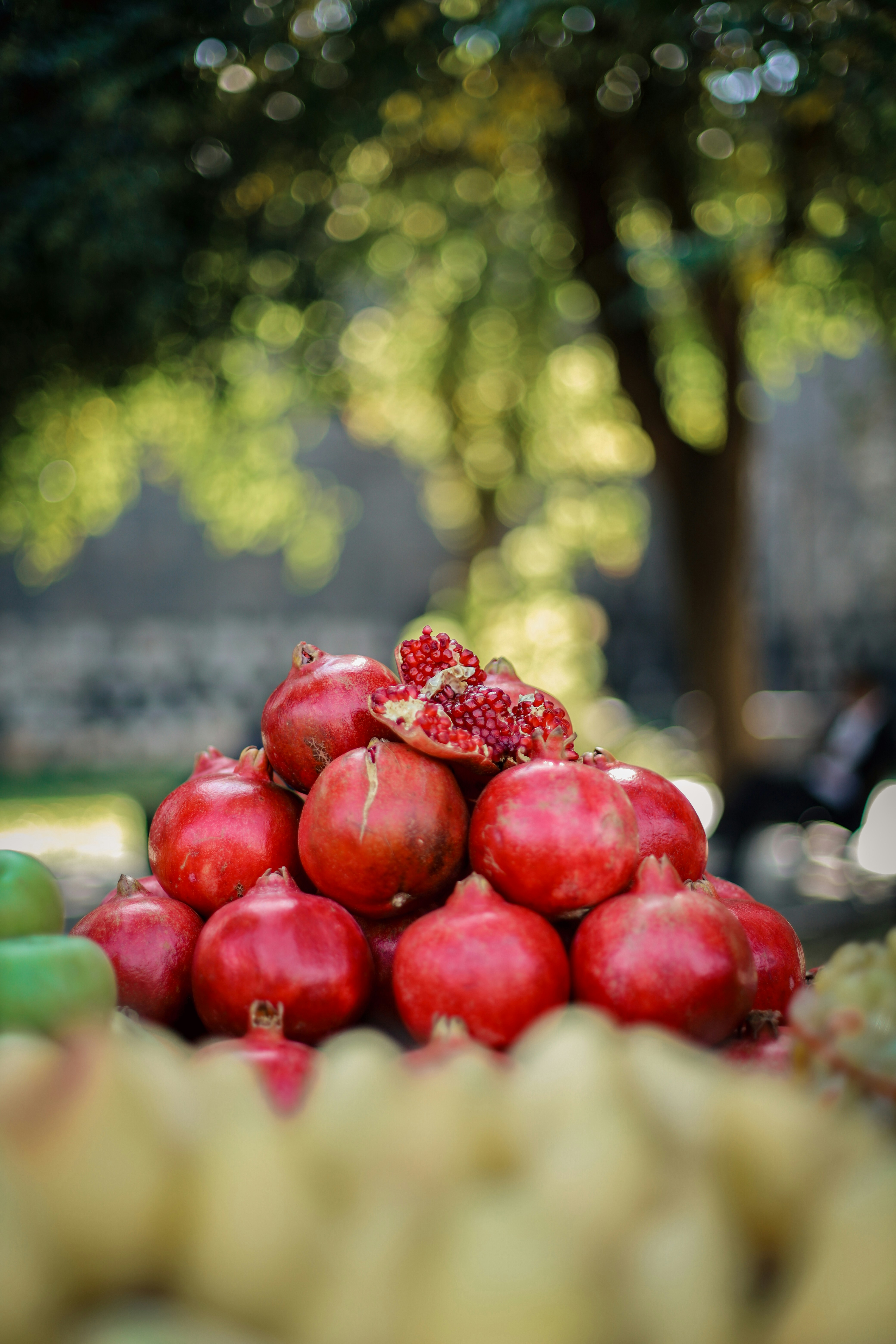 Pomegranate Pyramid at a Sunlit Market Stall