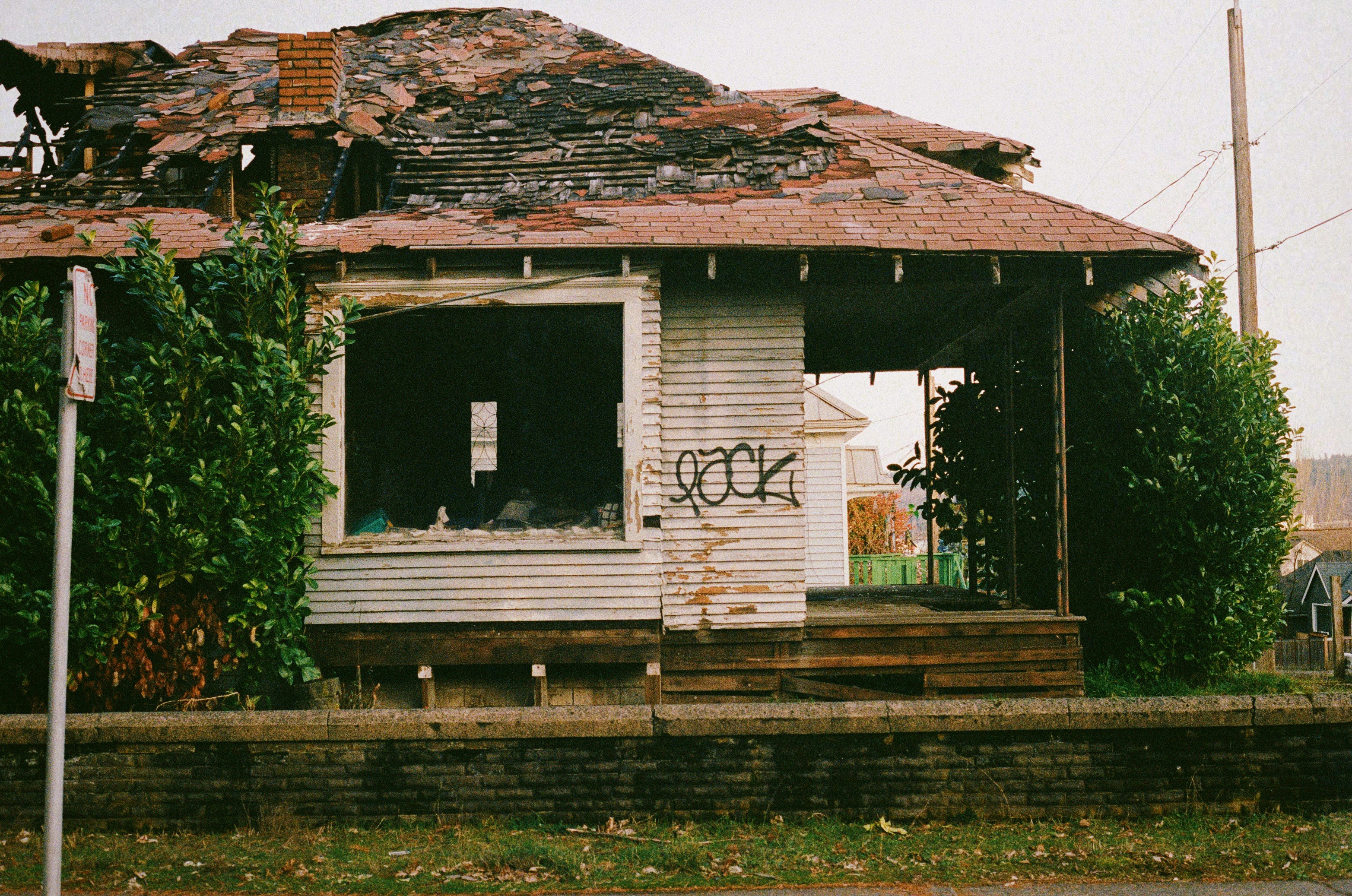 A run down house with graffiti on it photo – Free Film photography ...