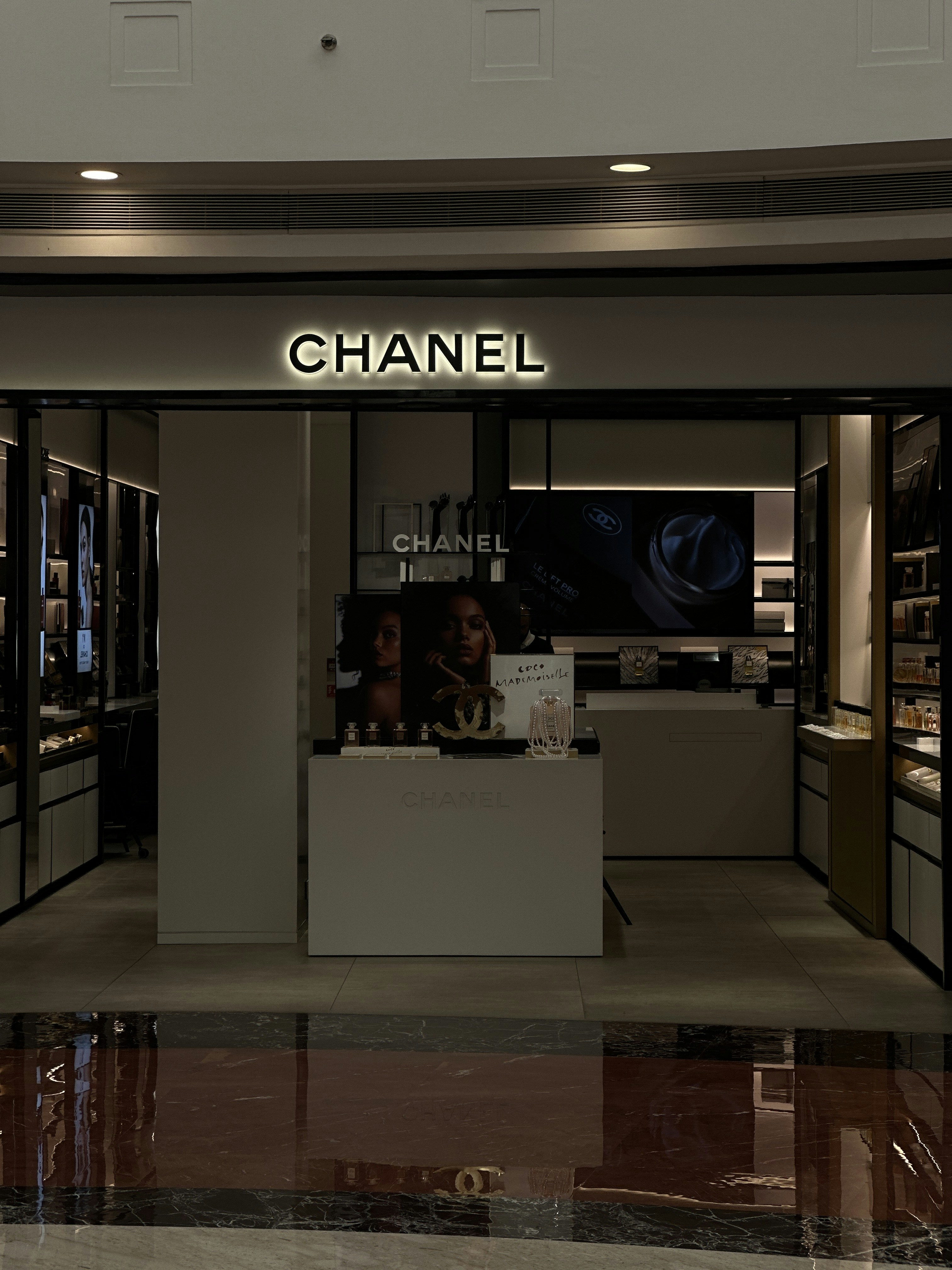 Chanel Under Soft Spotlight: Luxe Presence in a Dim Mall Gallery