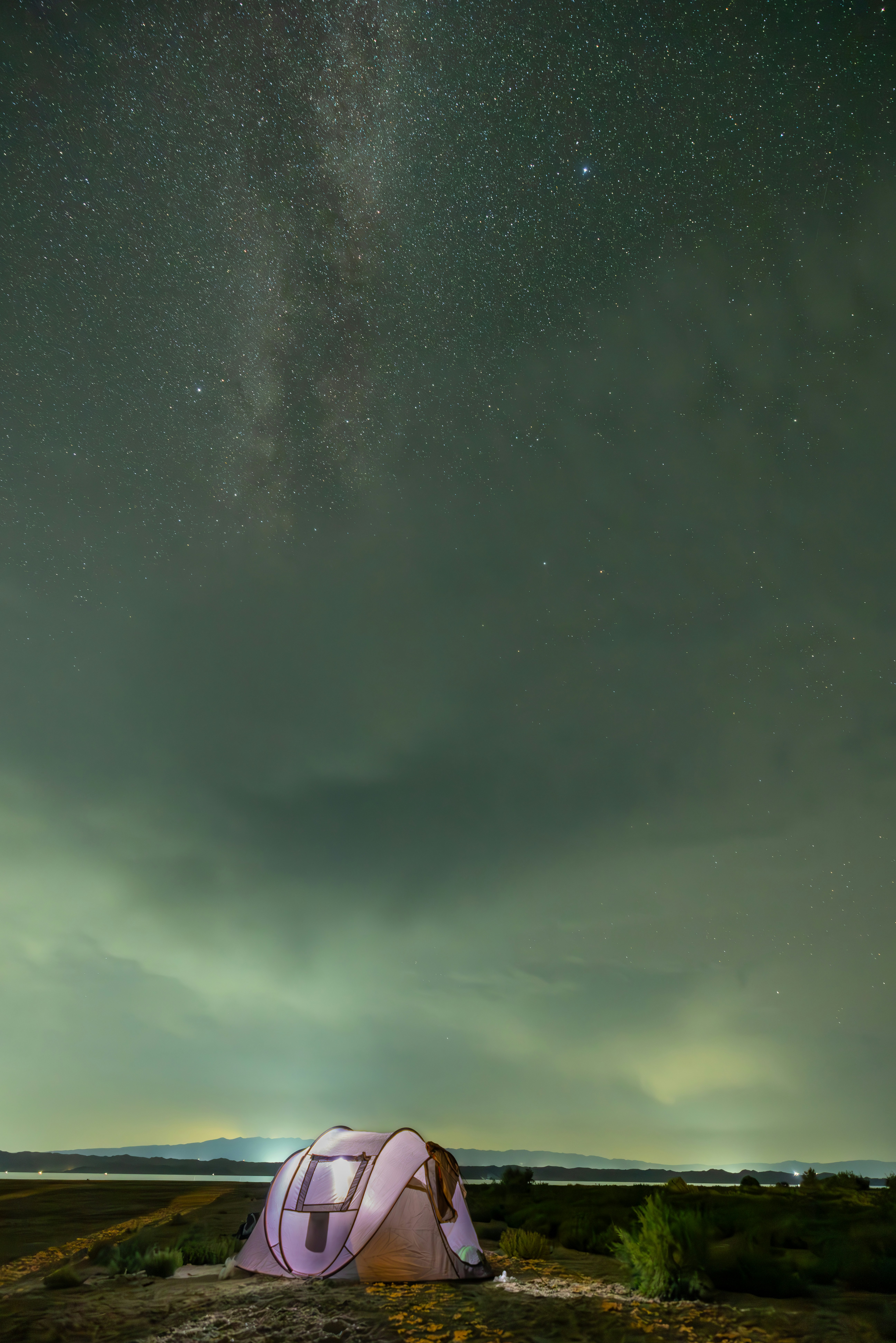 Milky Way Over a Pink Camping Tent by the Quiet Shore
