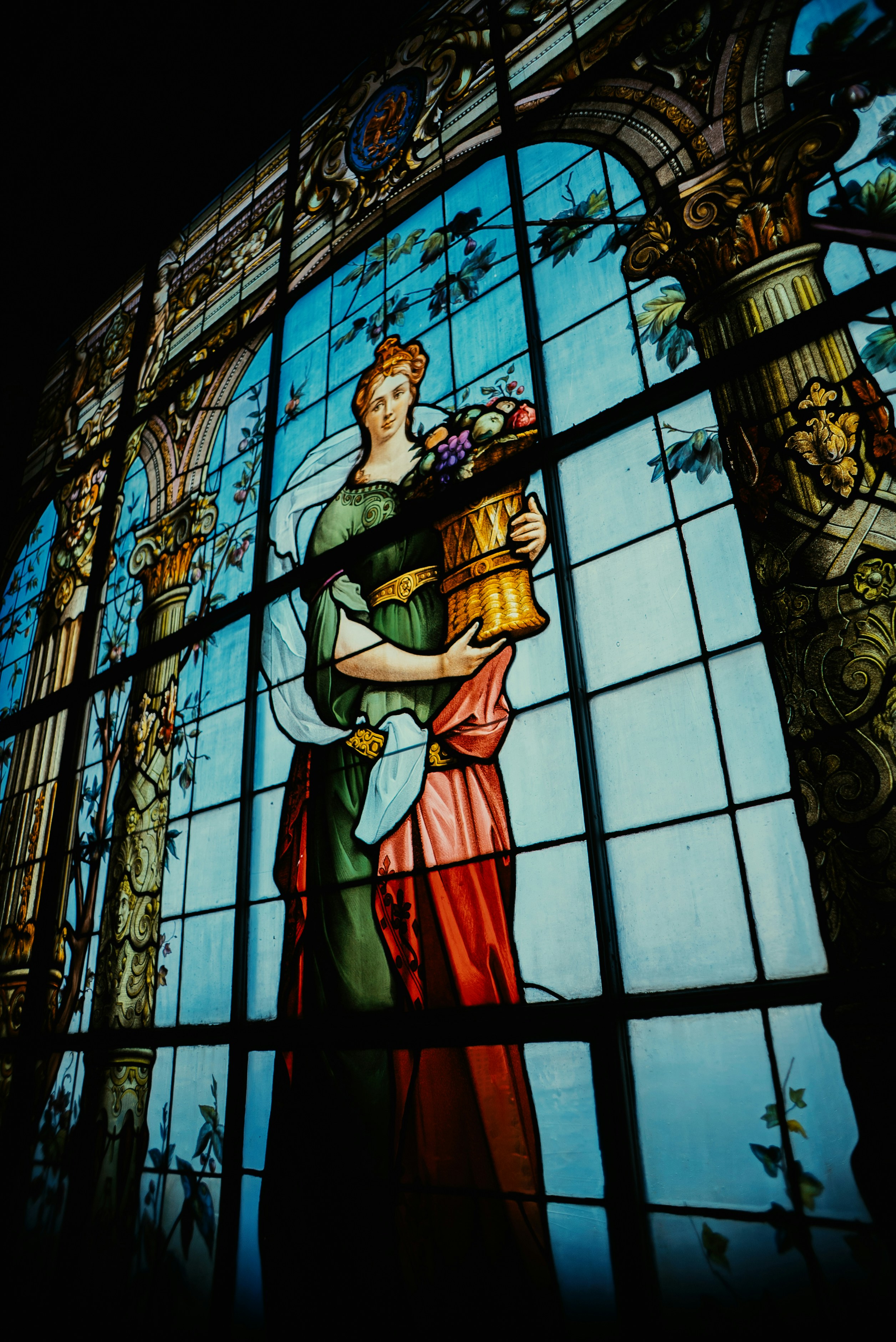 Archival Grace: Woman with Basket in a Grand Stained-Glass Arch